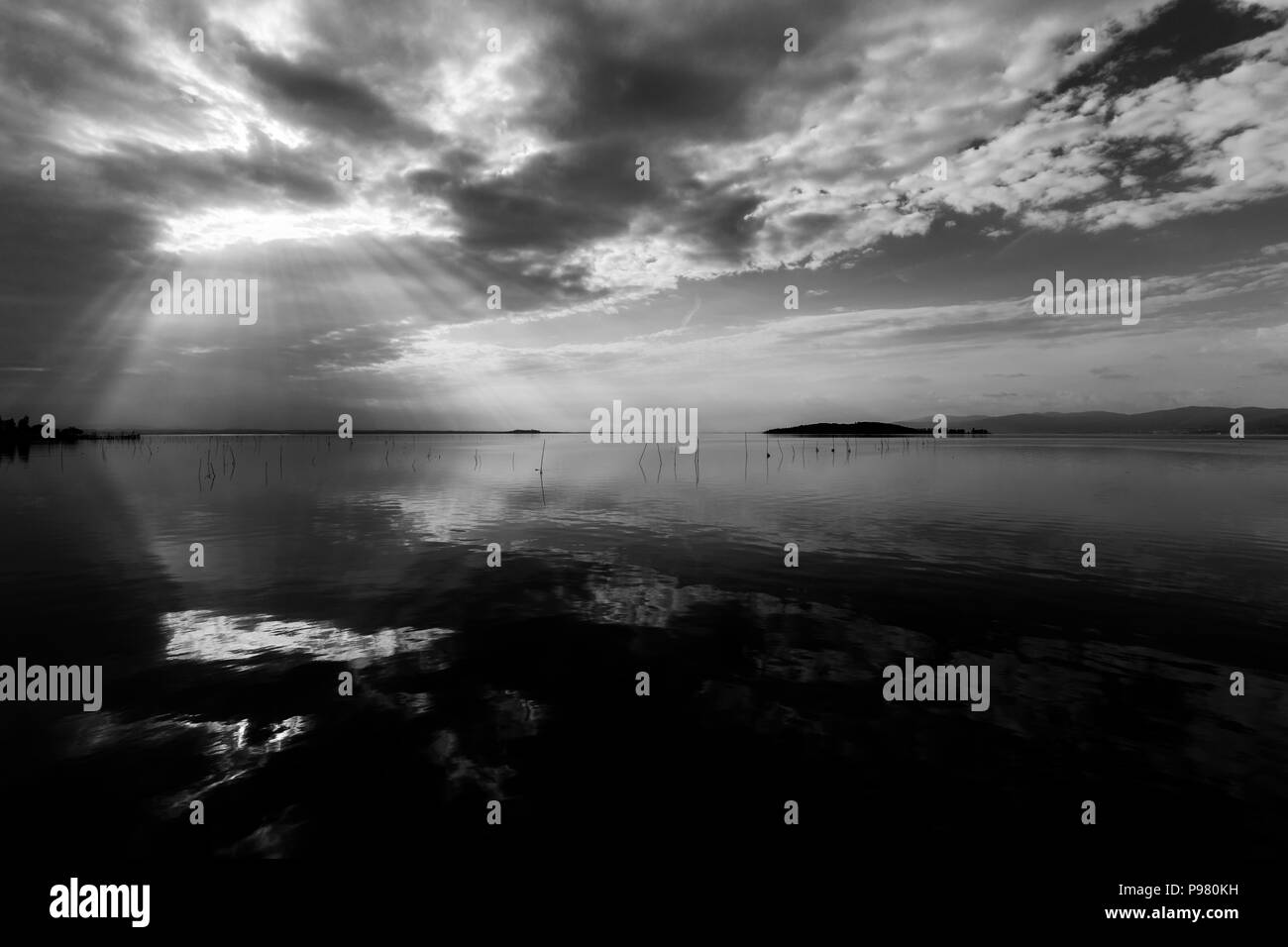 Perfectly symmetric and spectacular view of a lake, with clouds, sky ...