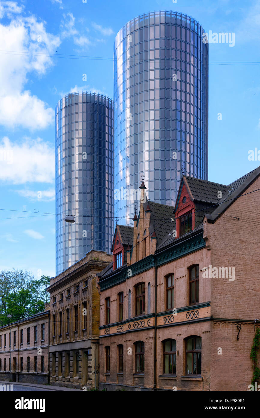 New skyscrapers on the background of blue sky with clouds over the old ...