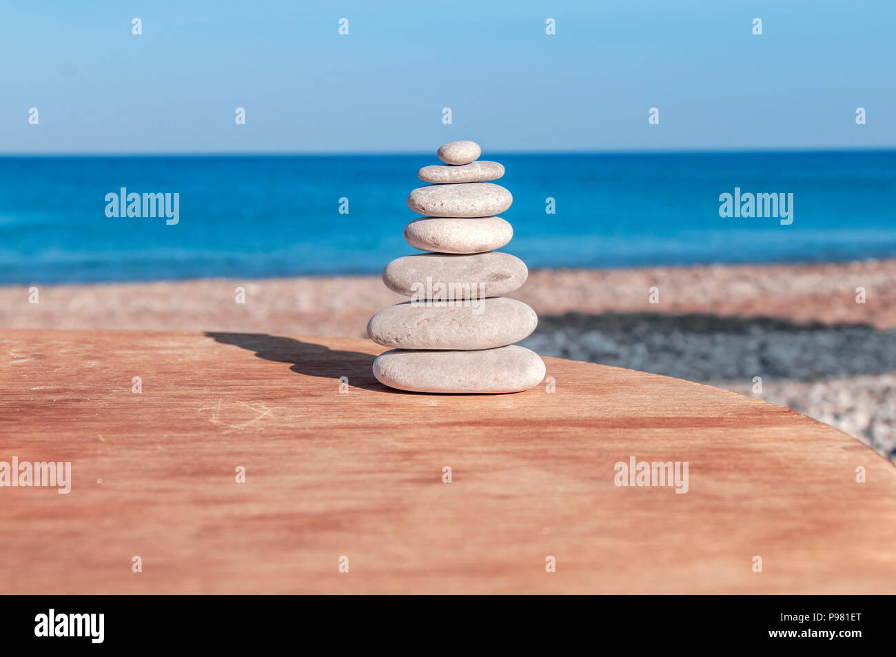 Beach round pebble stone set balance arrangement like zen symbol on ...