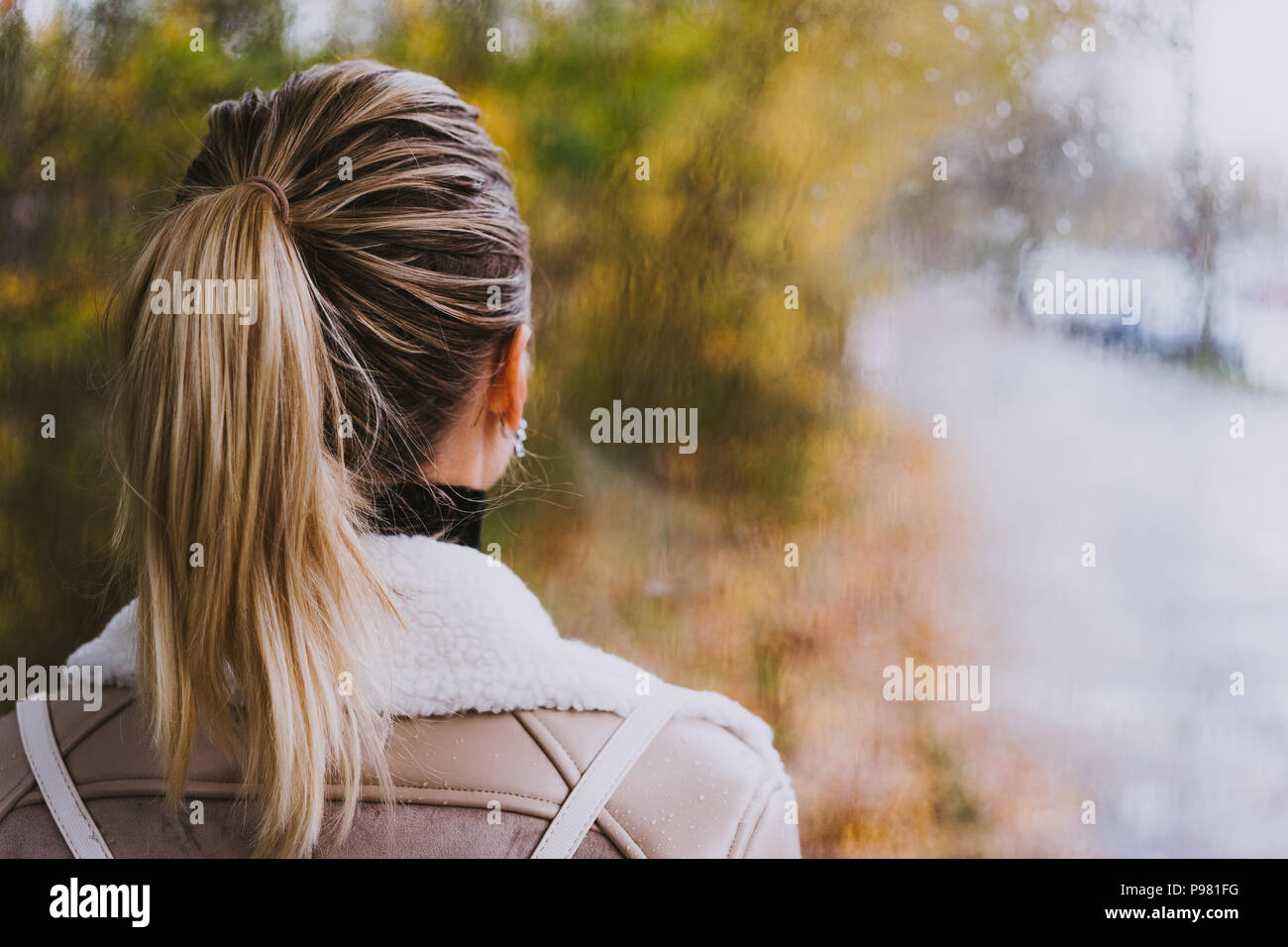 Woman looking through window rain hi-res stock photography and images ...