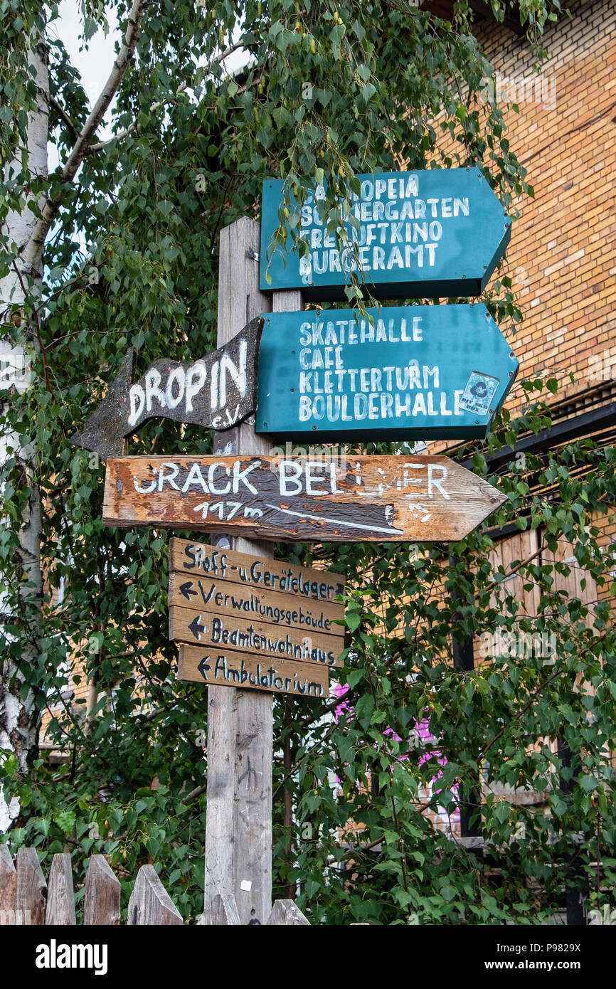 Berlin, Friedrichshain, RAW Gelände Wooden sign points to clubs abd ...