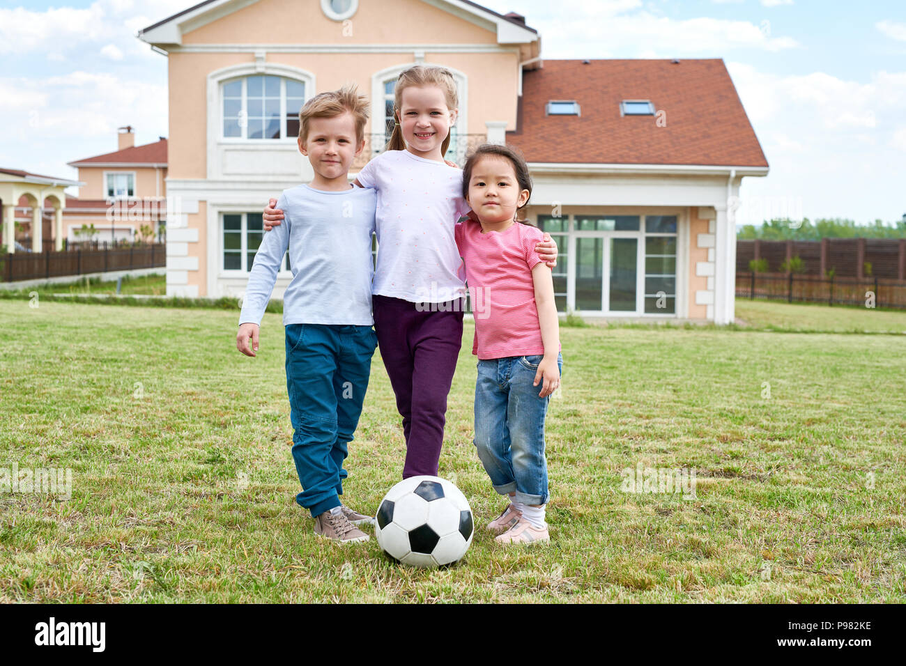 Three Kids Posing Outdoors Stock Photo - Alamy