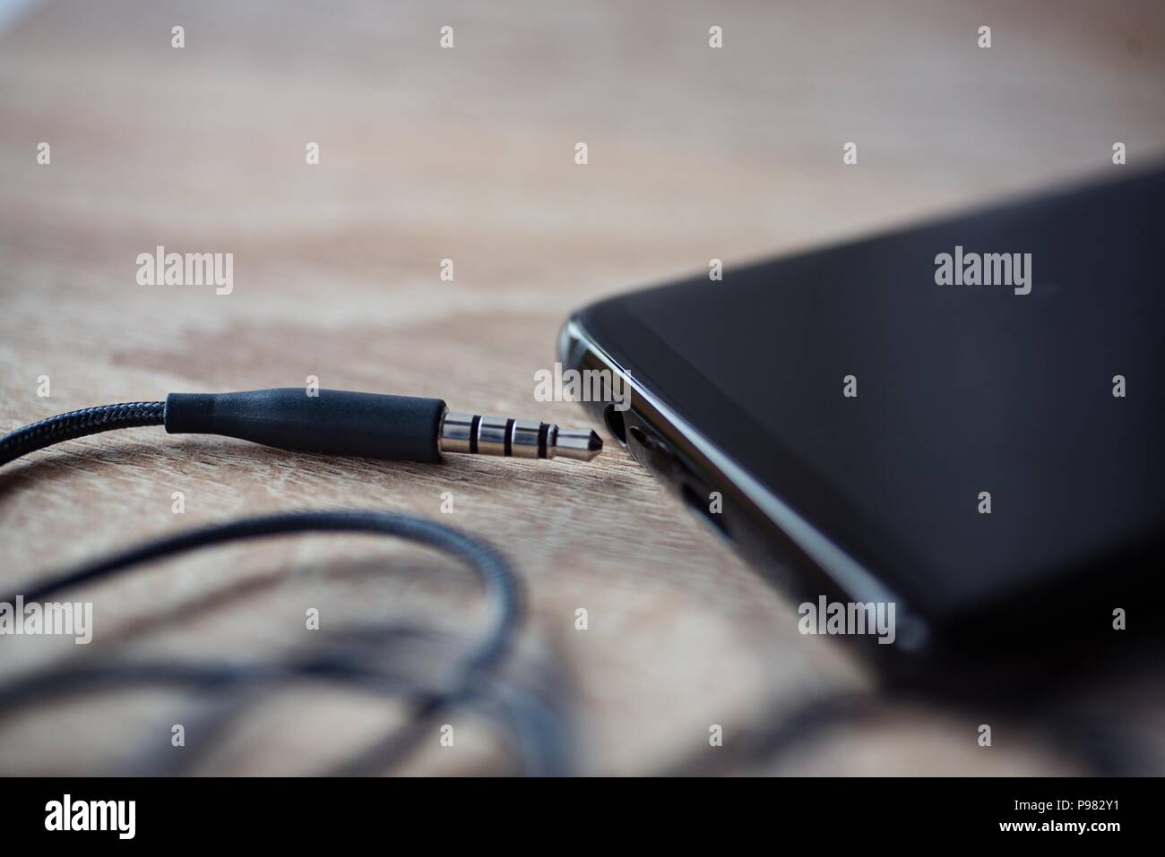 Stereo headphones jack connector and smart phone Stock Photo - Alamy