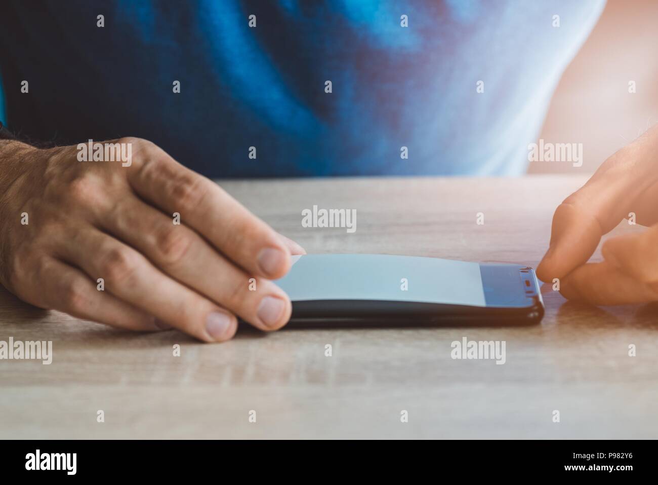 Man applying protective screen foil on his smartphone touchscreen Stock ...