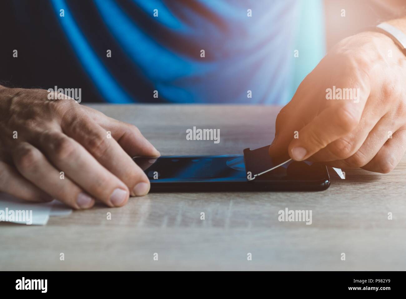 Man applying protective screen foil on his smartphone touchscreen Stock ...