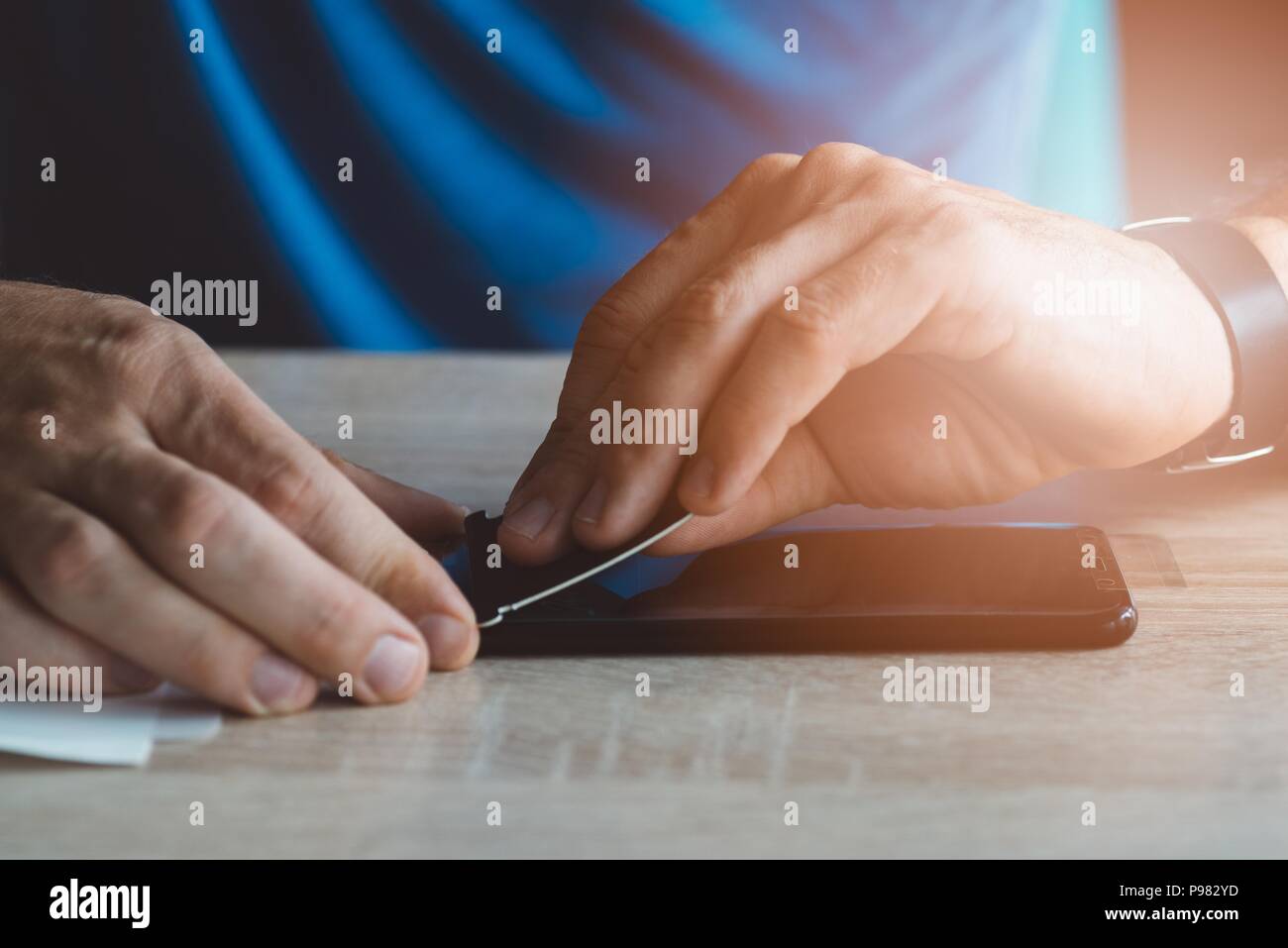 Man applying protective screen protector on his smartphone touchscreen ...