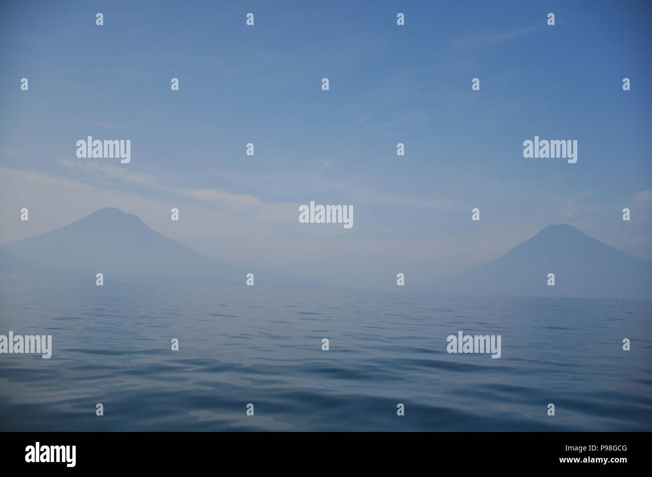 Lake Atitlan in early morning haze with san pedro volcano and Atitlan ...