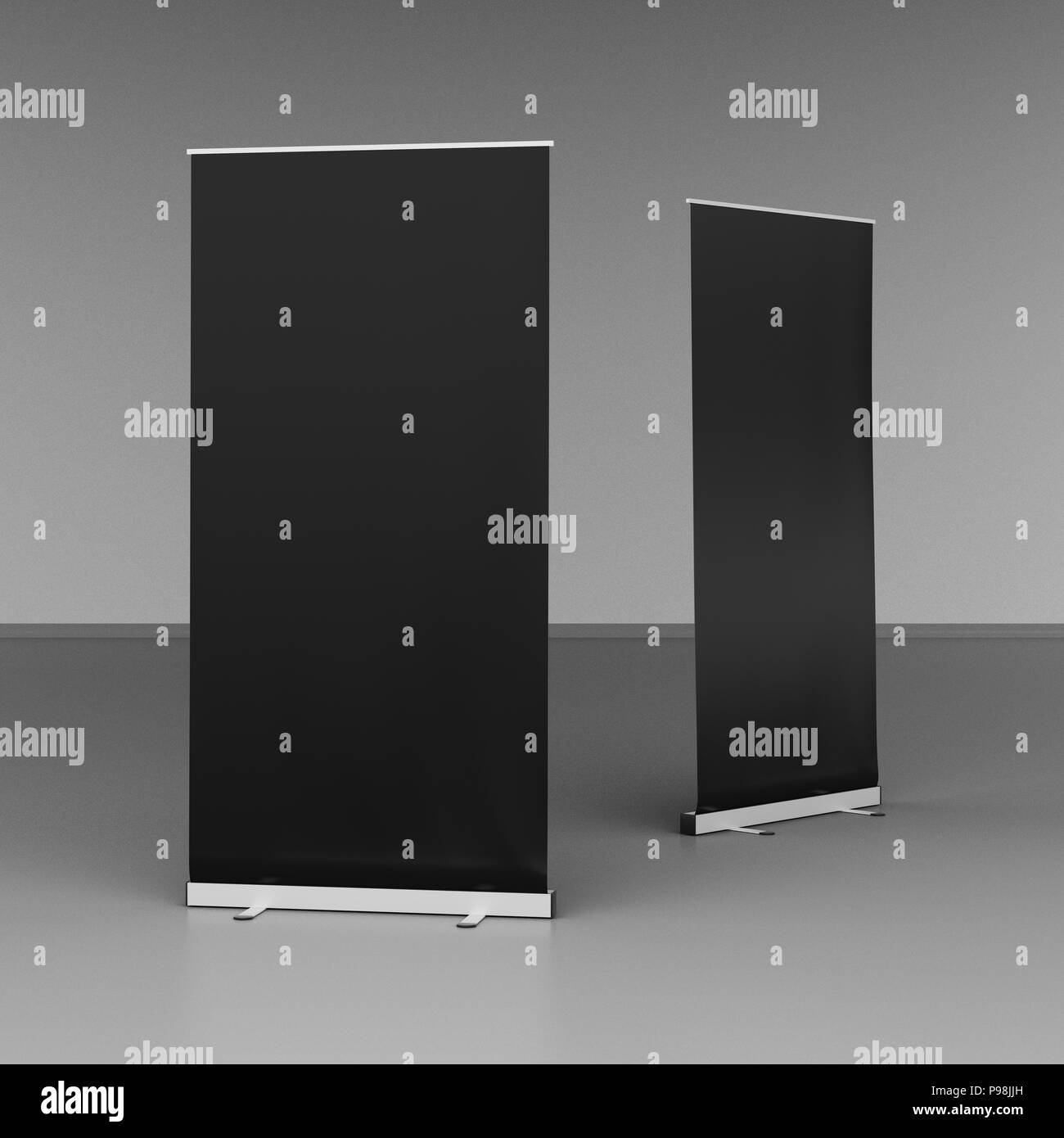 Blank black roll up banner stands on gray floor. Include clipping paths ...
