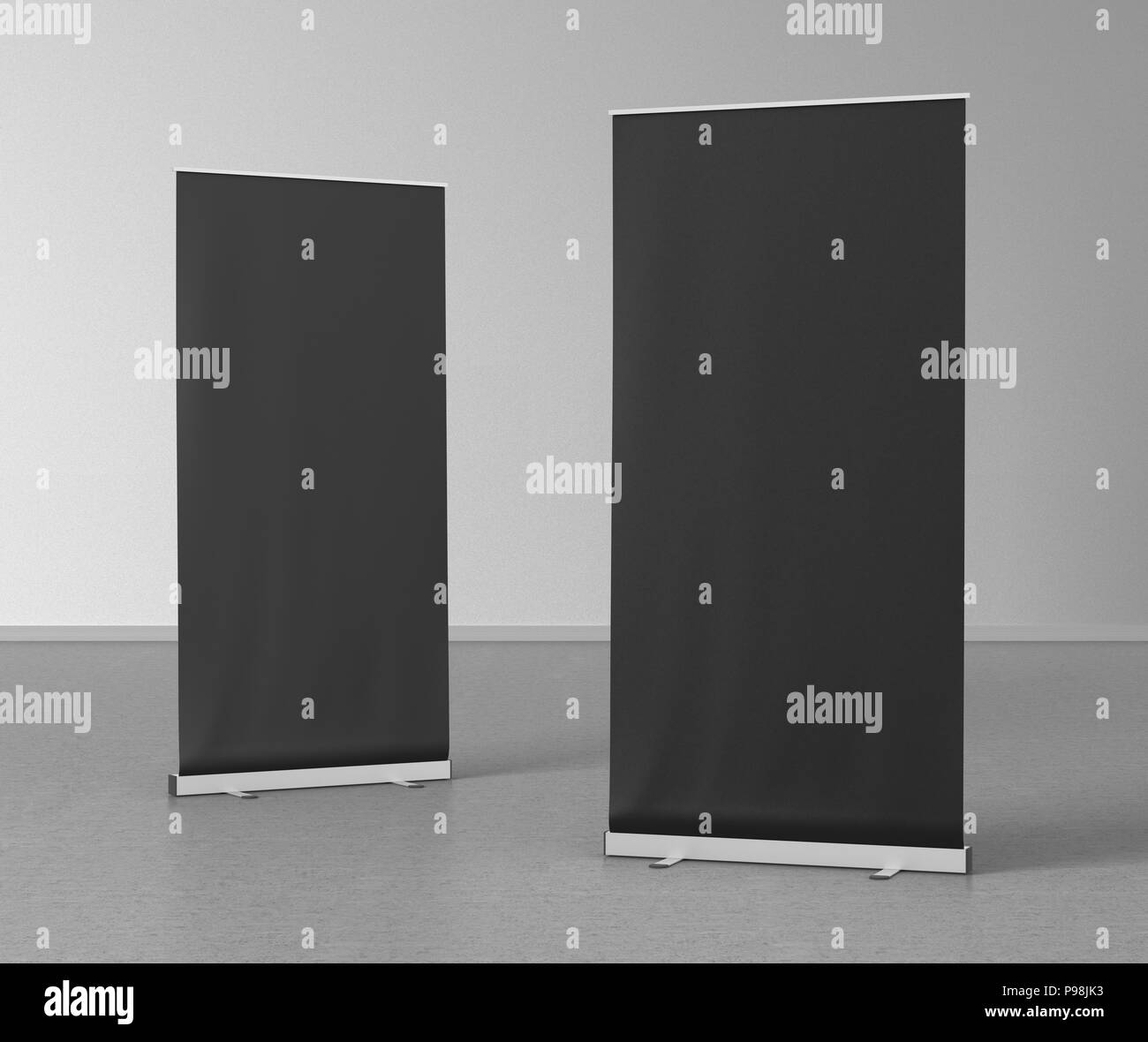 Blank black roll up banner stands on gray floor. Include clipping paths ...