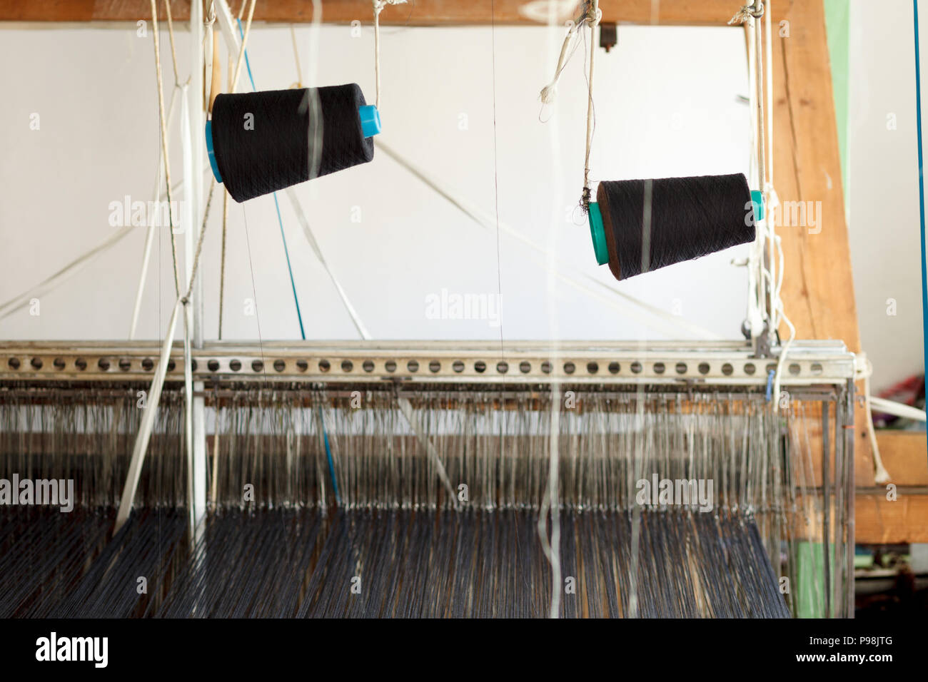 Vintage weaving loom and thread of yarn. Closeup Stock Photo - Alamy