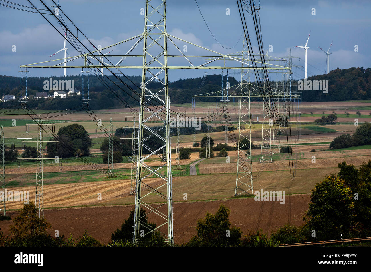 Pylons and cables stretch over the German landscape with wind turbines ...