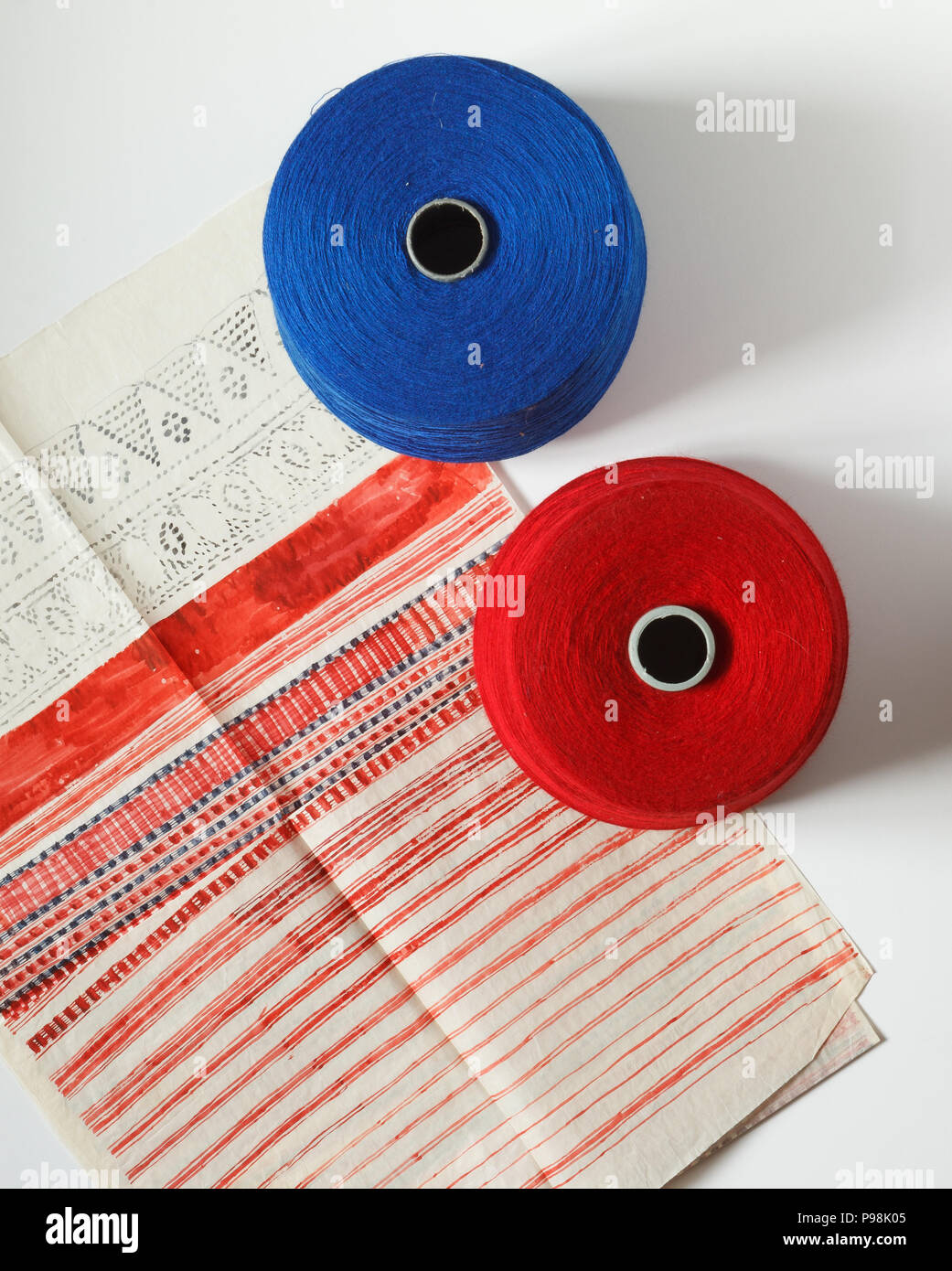 Still life of textile manufactory. Spools of thread, sketches, textile ...