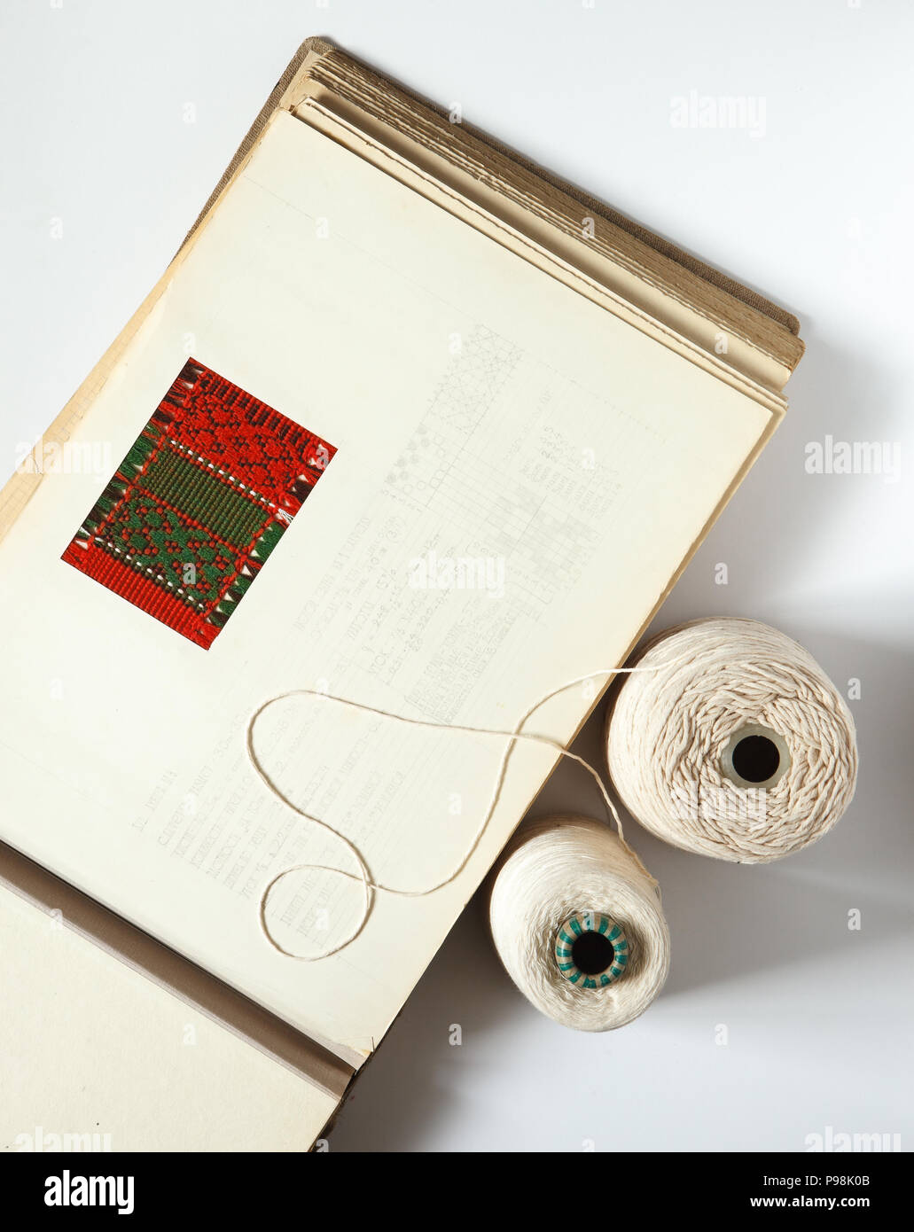 Still life in a textile manufactory. Spools of thread, sketches ...