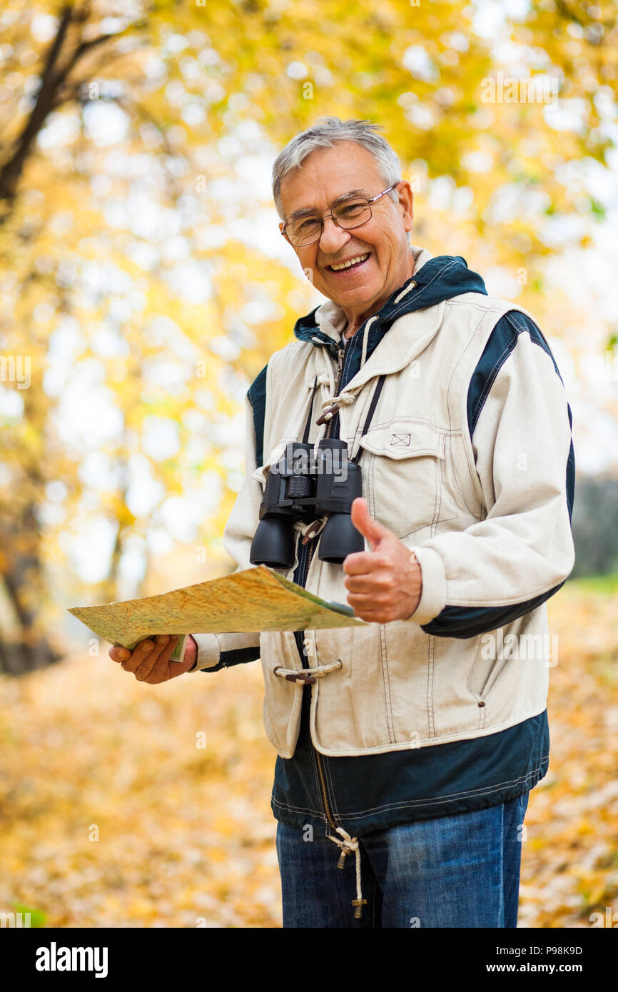 Active retirement, senior man is hiking in forest Stock Photo - Alamy