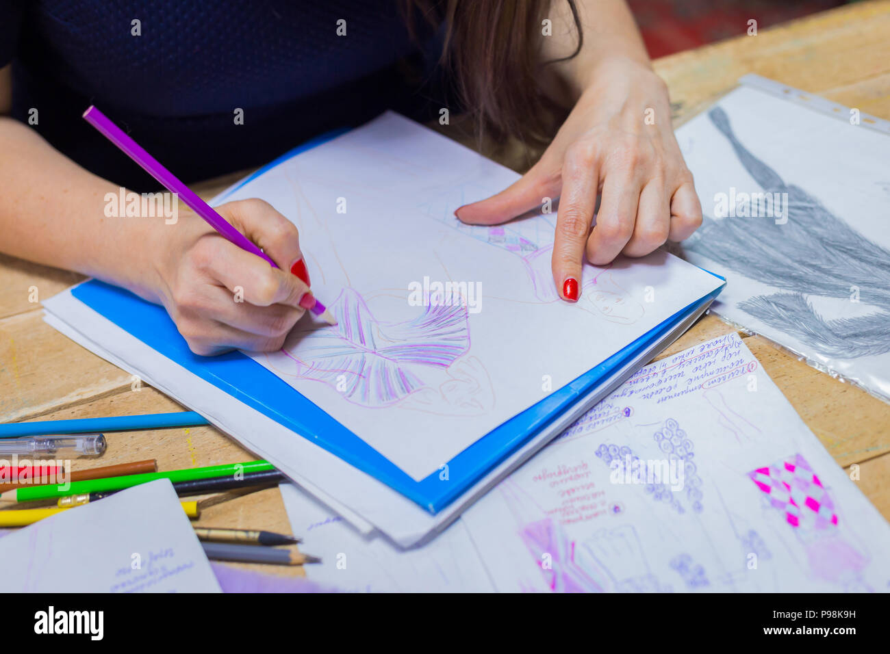 Fashion designer drawing design sketch Stock Photo - Alamy