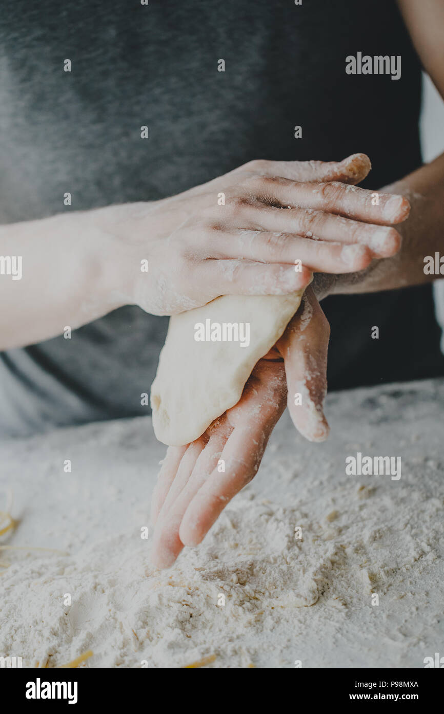Process of cutting dough making dish cooking homemade dough. Chef makes ...