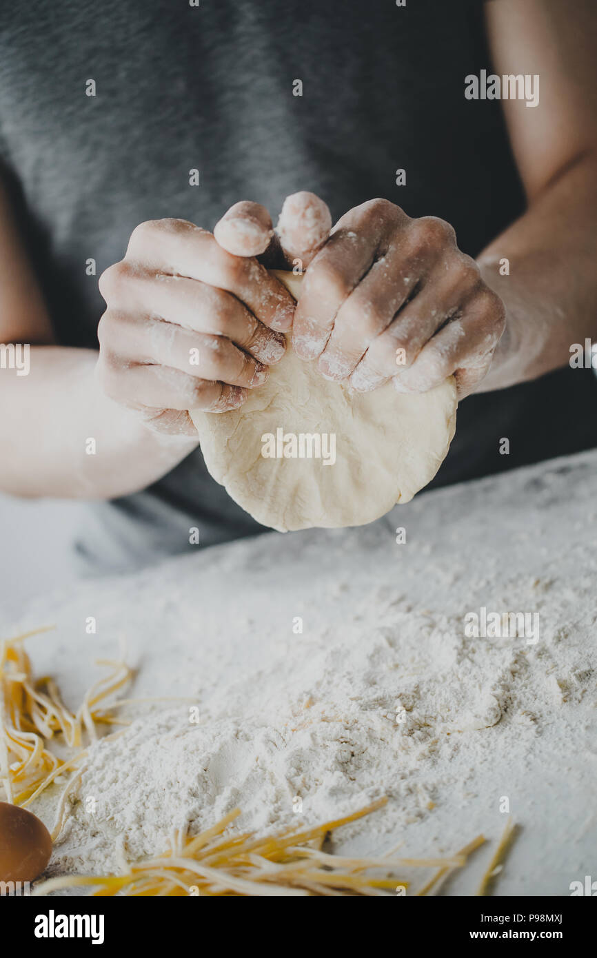 Process of cutting dough making dish cooking homemade dough. Chef makes ...