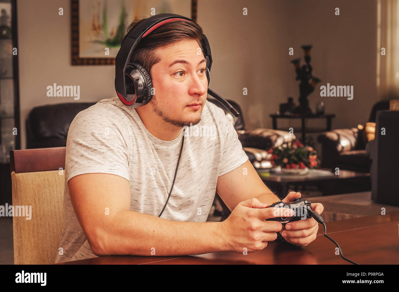 Concentrated man playing video games. Addicted to games playing at home ...