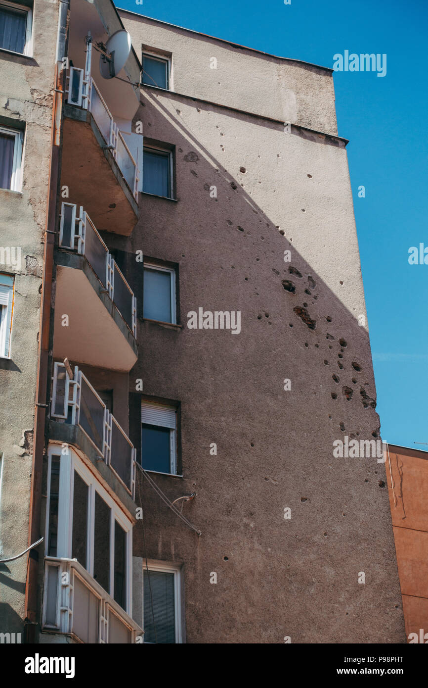 A streak of shrapnel damange remains visible on the exterior of an ...