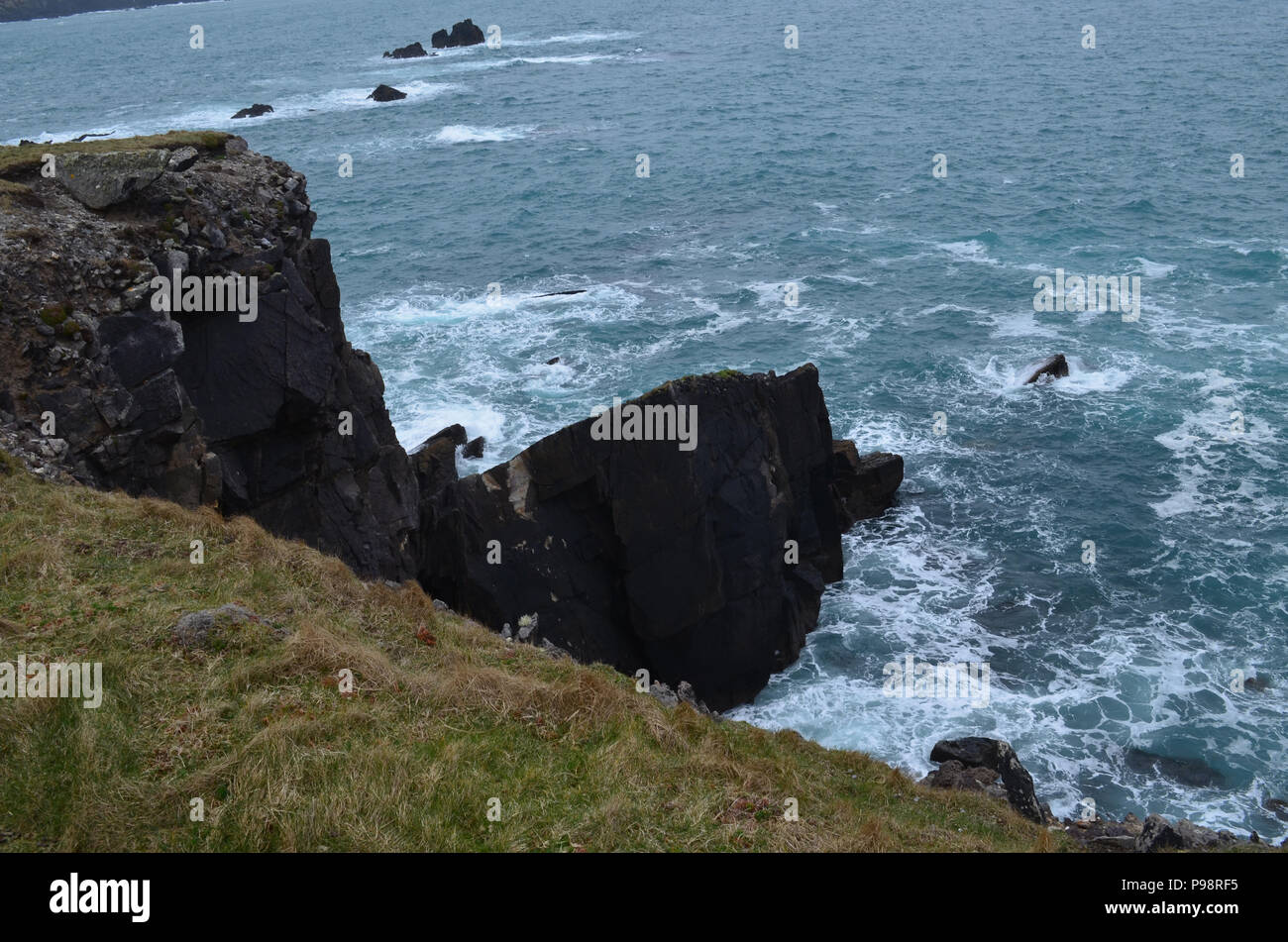 Steep drop into the waters from the slea head pennisula in Ireland ...