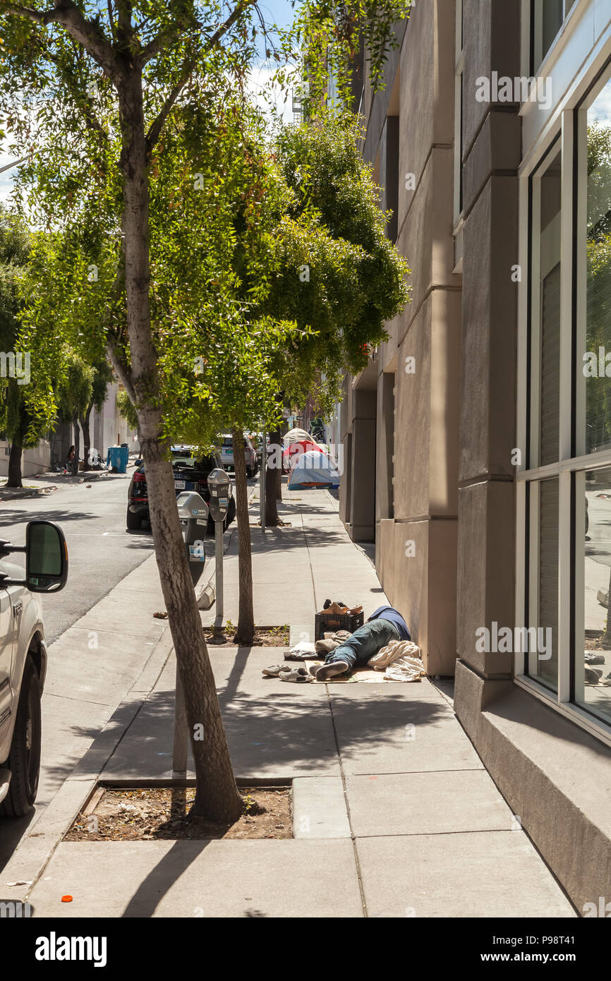 Homeless man was sleeping on the sidewalk in San Francisco, California ...