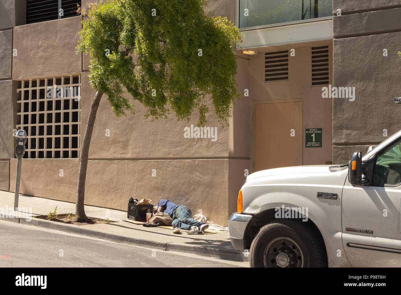 Homeless man was sleeping on the sidewalk in San Francisco, California ...