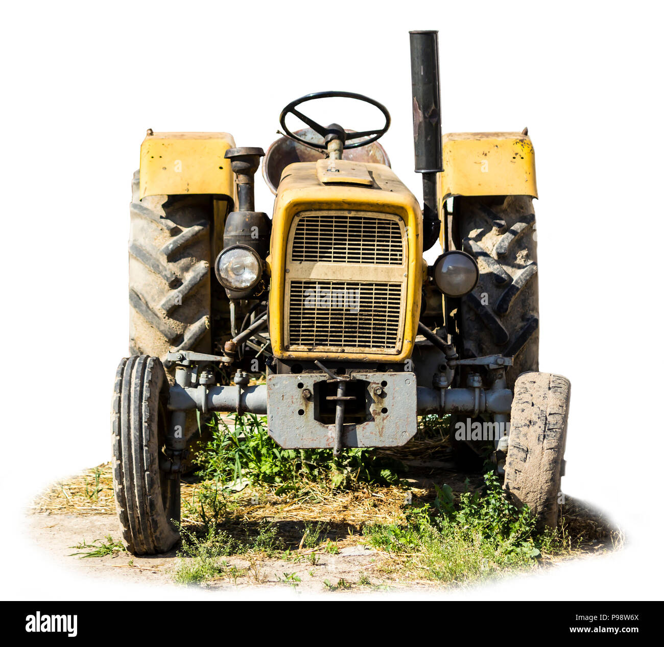 An old tractor produced in the 70s of the 20th century. Isolated front ...