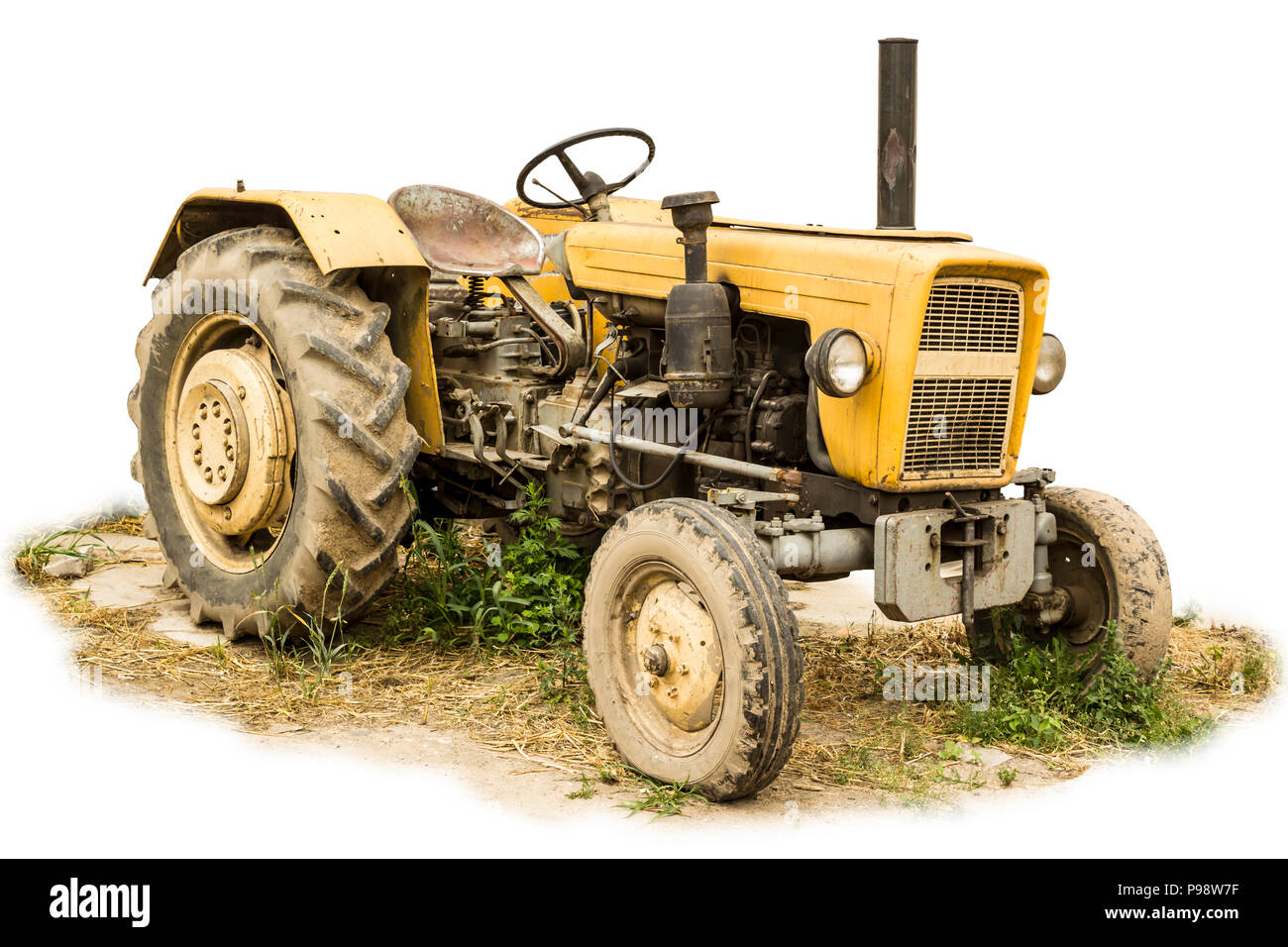 An old tractor produced in the 70s of the 20th century. Isolated photo ...