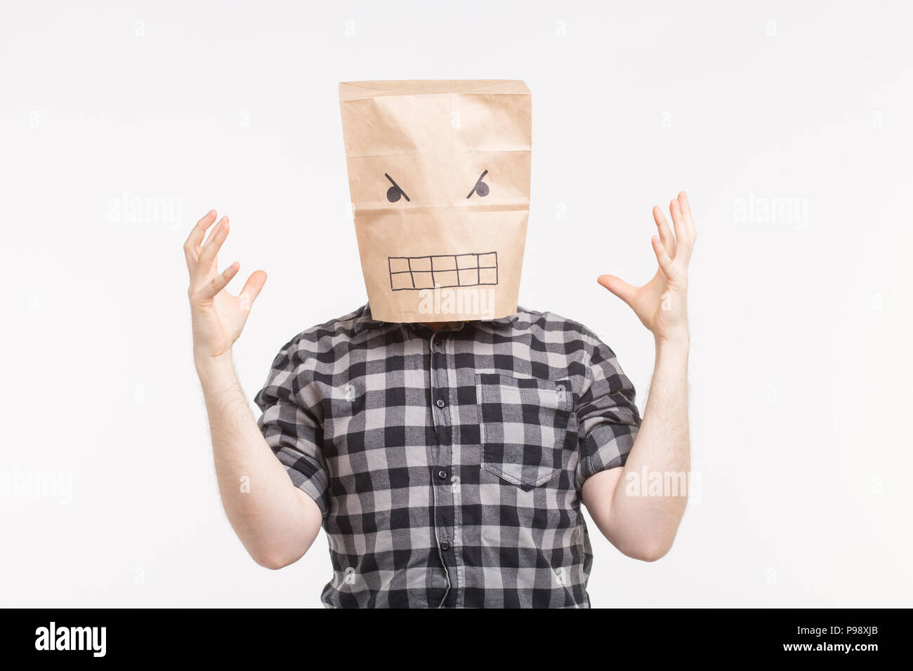 Angry man in paper bag mask on his head raising hands Stock Photo - Alamy