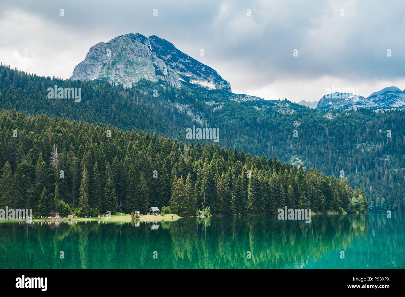 The forest and pristine blue waters of Crno Jezero (Black Lake) on a ...
