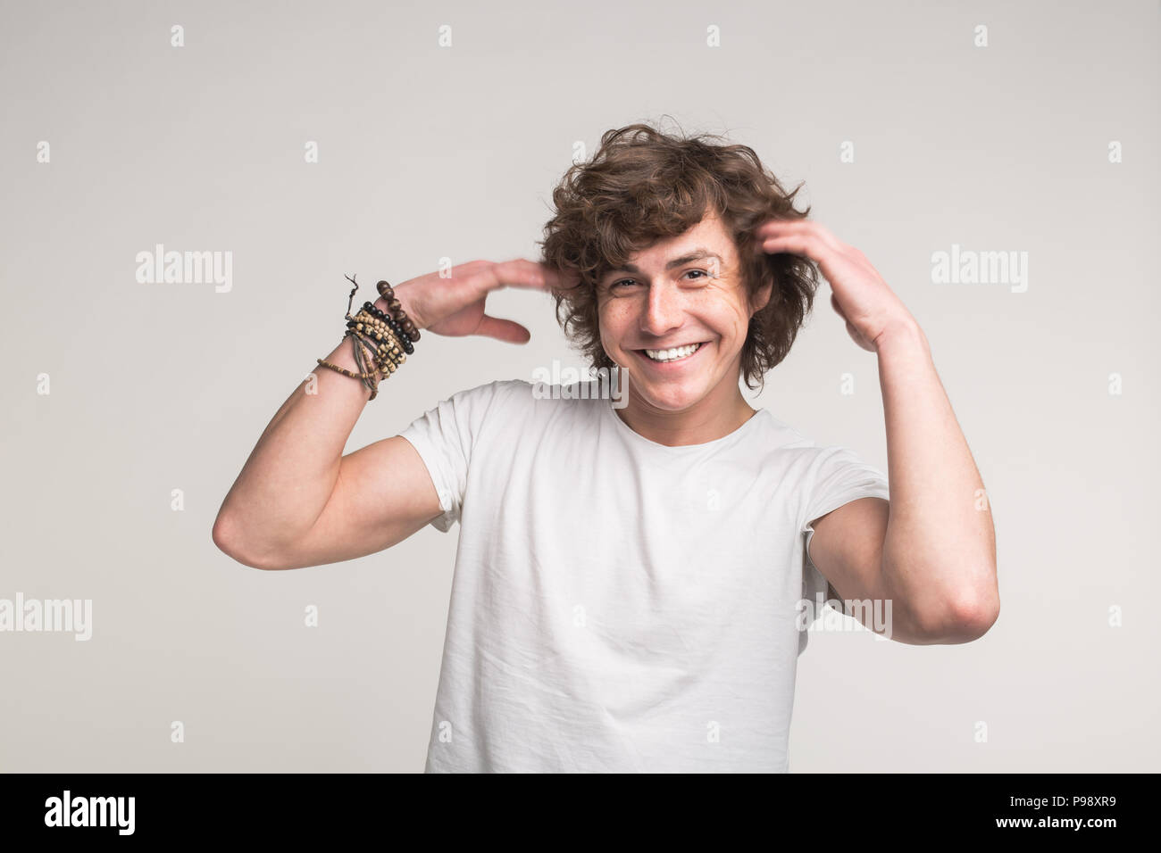 Happy handsome young man with moving arms on white background Stock ...