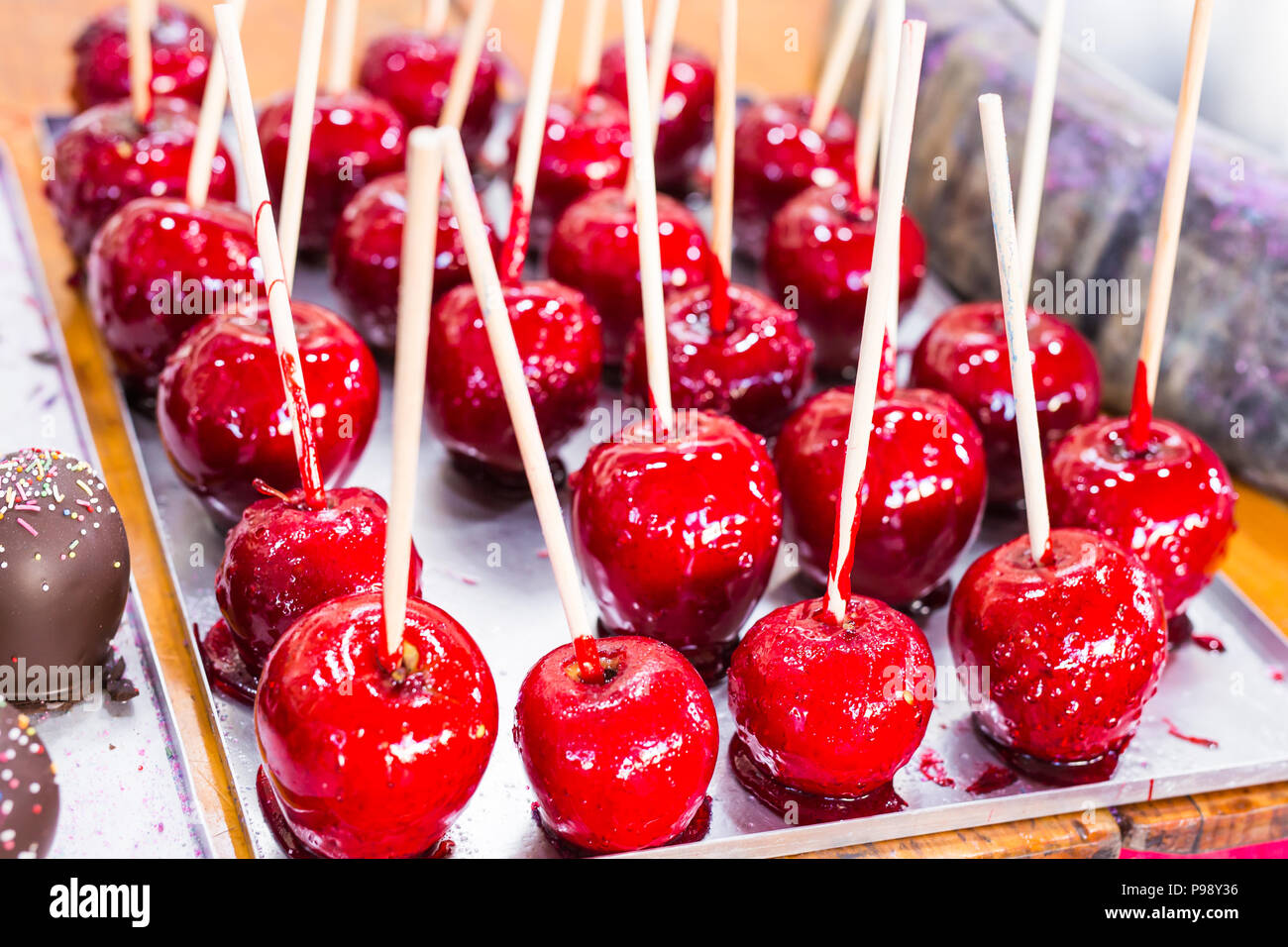 Red apples on a stick in caramel yum yum Stock Photo - Alamy