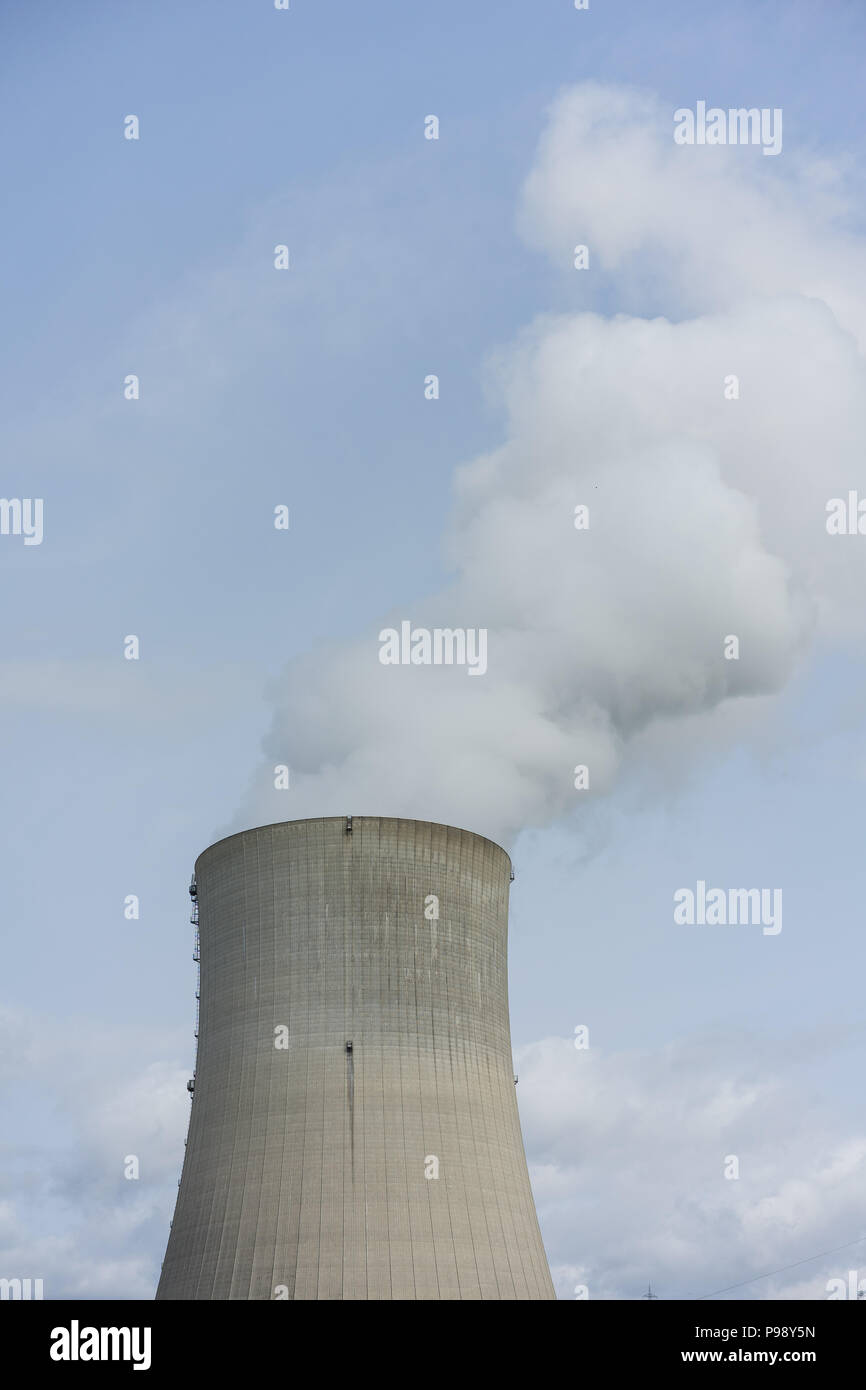 nuclear power plant chimney with condensation smoke on a cloudy day ...