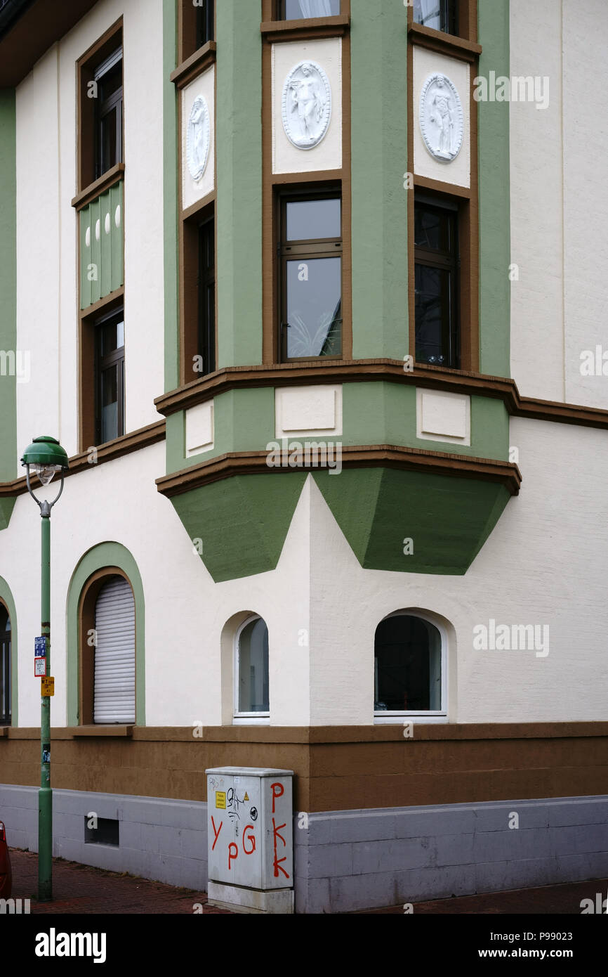The corner of a decorated with stucco decorations house with bay window ...