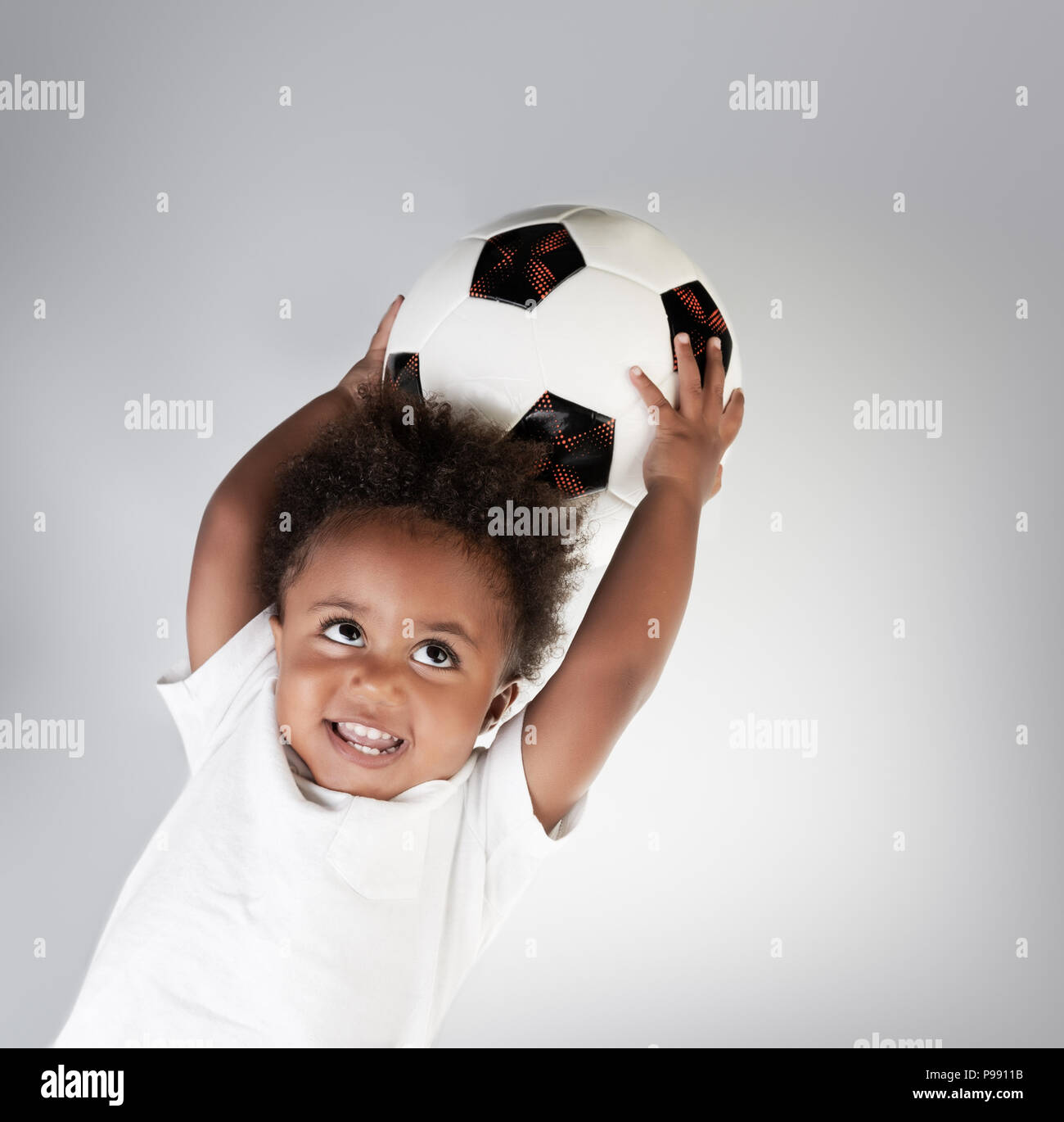 Portrait of a cute little boy with the ball, adorable small goalkeeper ...