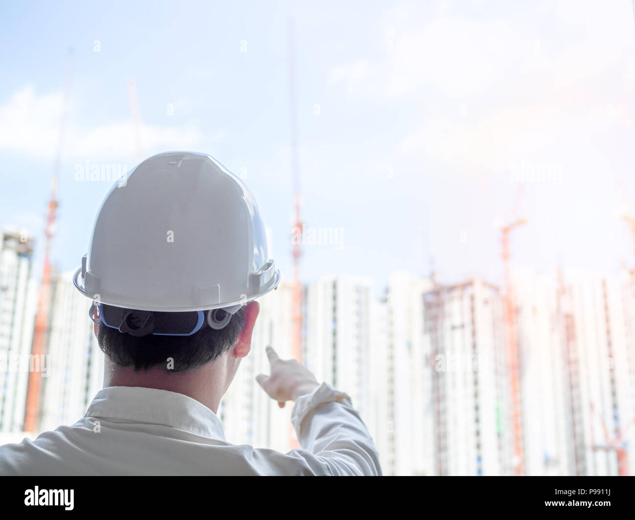 Engineer man back view wearing white hard safety helmet and white shirt ...