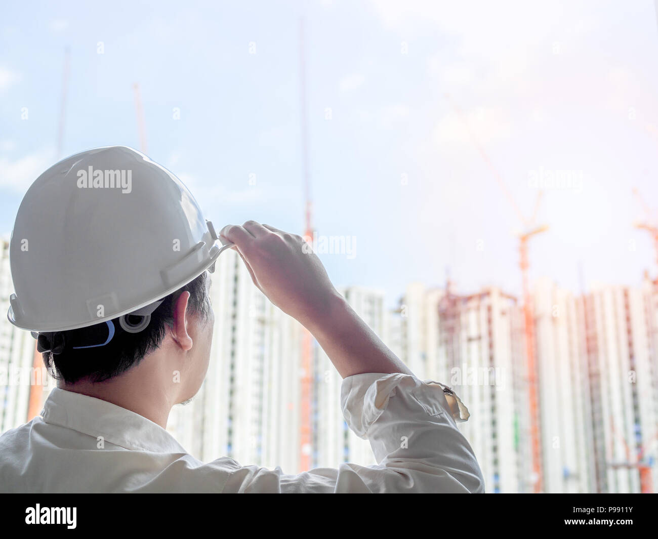 Engineer man back view wearing white hard safety helmet and white shirt ...