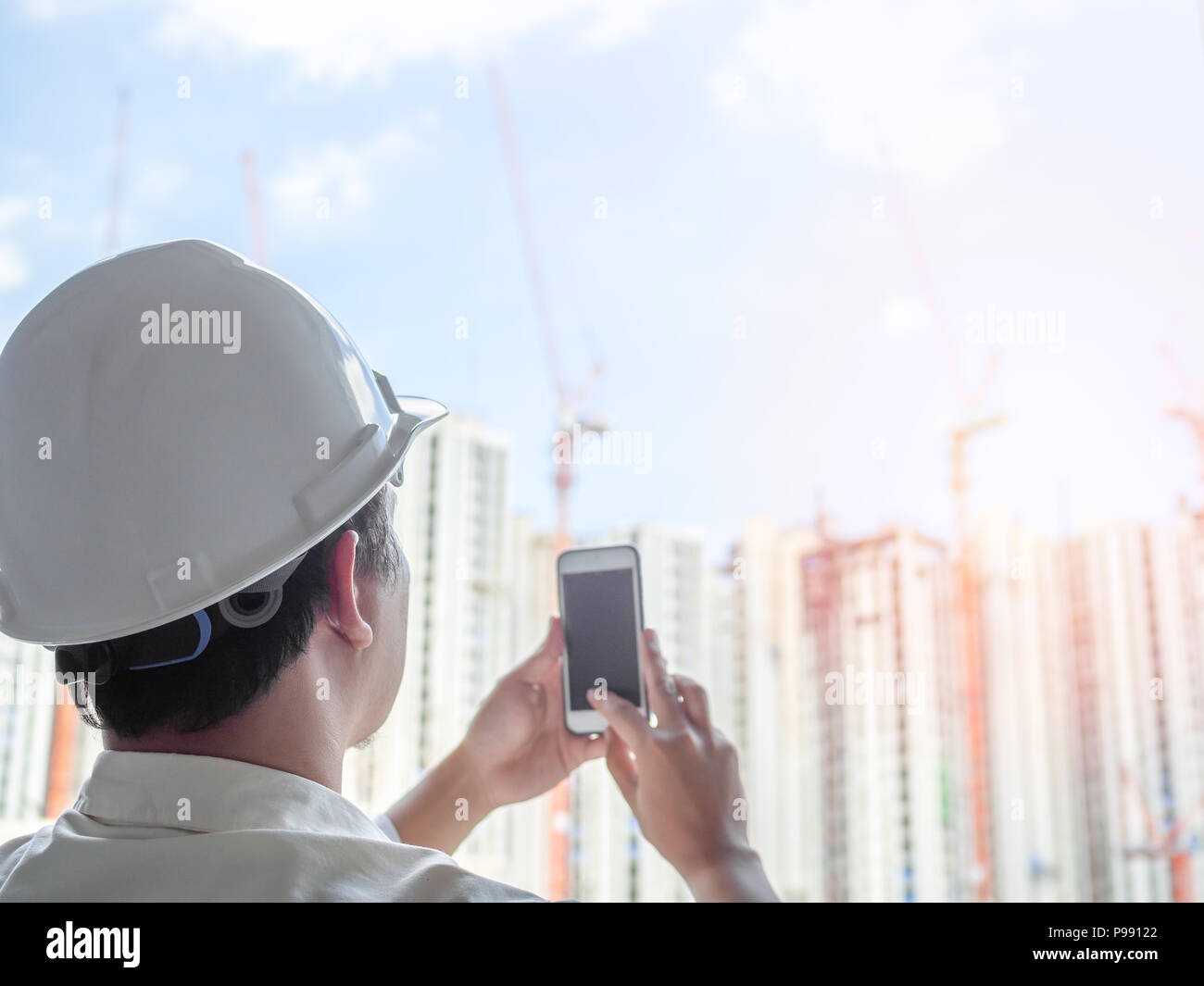 Engineer man back view wearing white hard safety helmet and white shirt ...