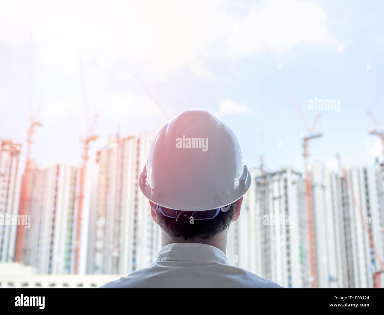 Engineer man back view wearing white hard safety helmet and white shirt ...