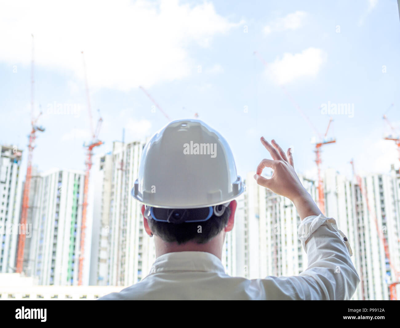 Engineer man back view wearing white hard safety helmet and white shirt ...