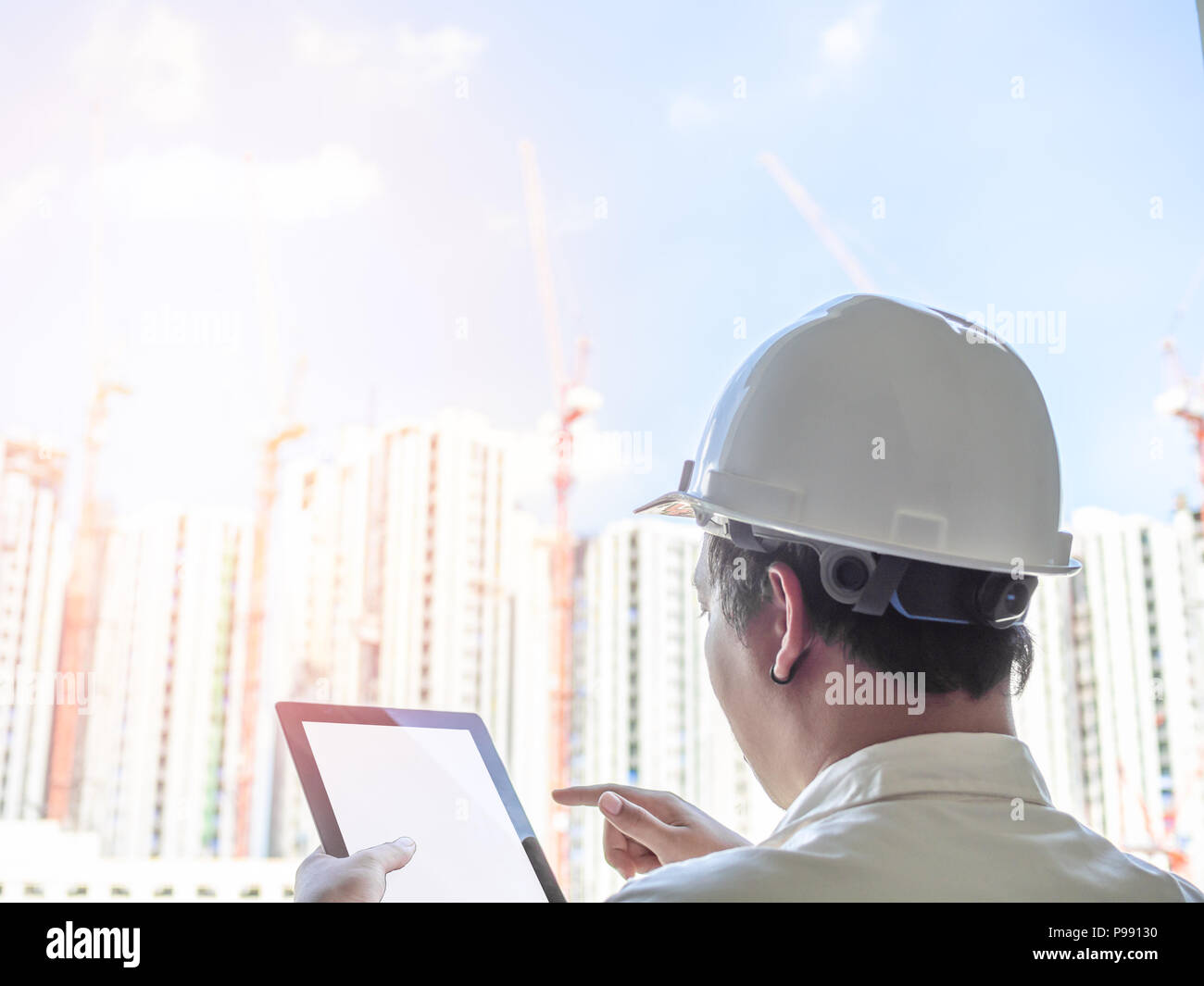 Engineer man back view wearing white hard safety helmet and white shirt ...