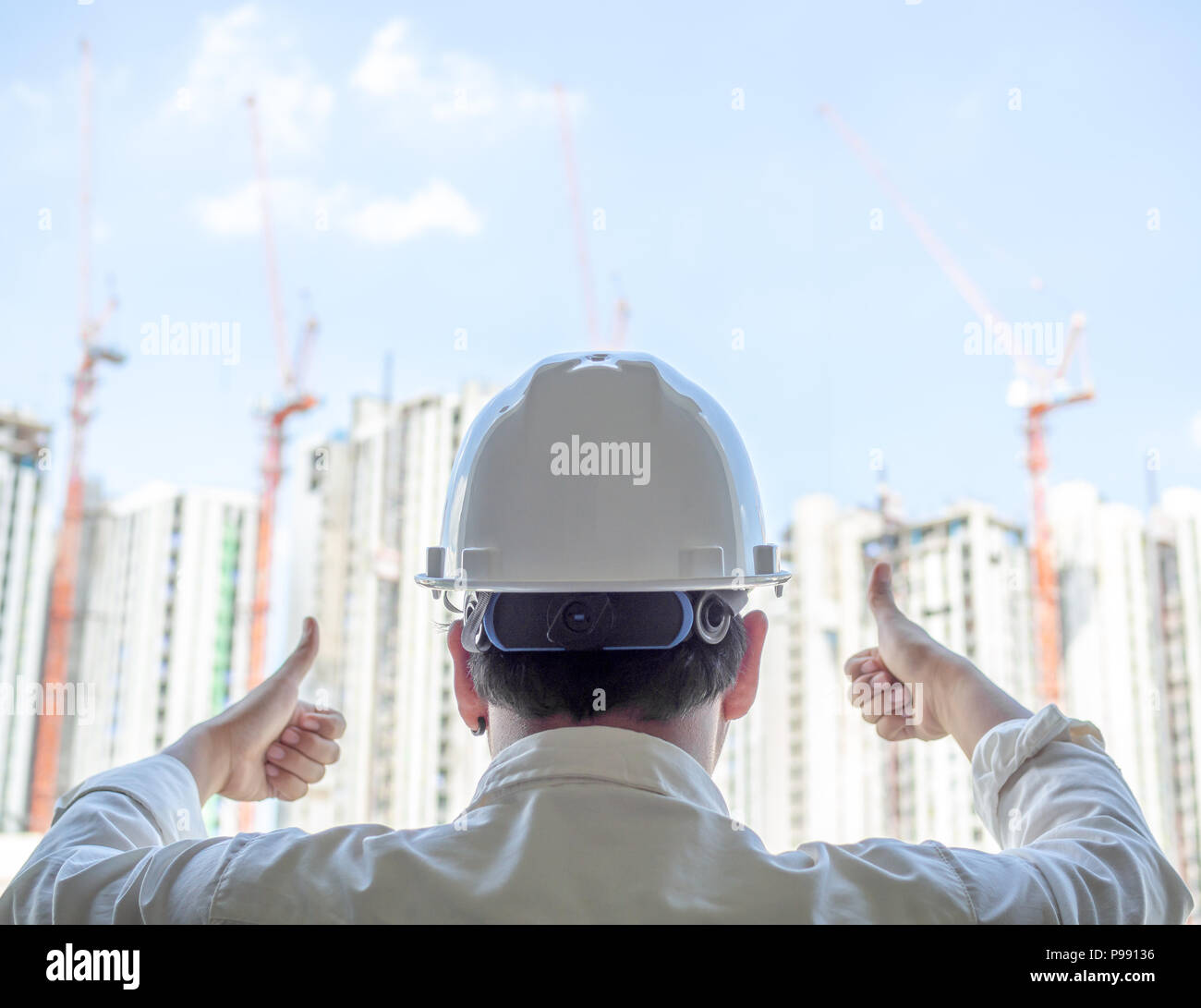 Engineer man back view wearing white hard safety helmet and white shirt ...