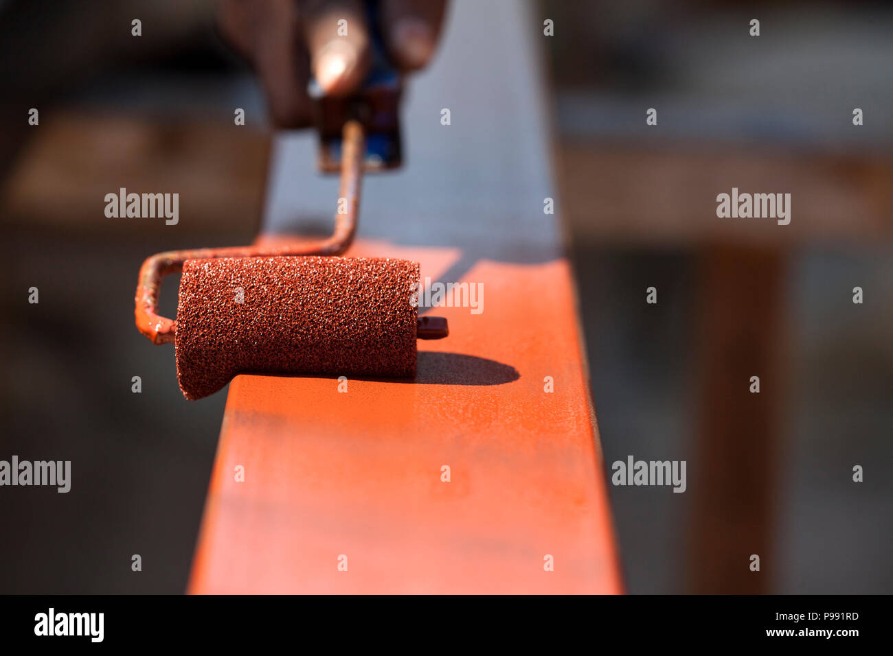 Painting of metal pipe using a roller with the basic paint Stock Photo ...