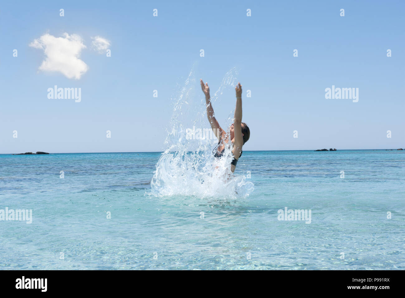 Woman splashing in water hi-res stock photography and images - Alamy