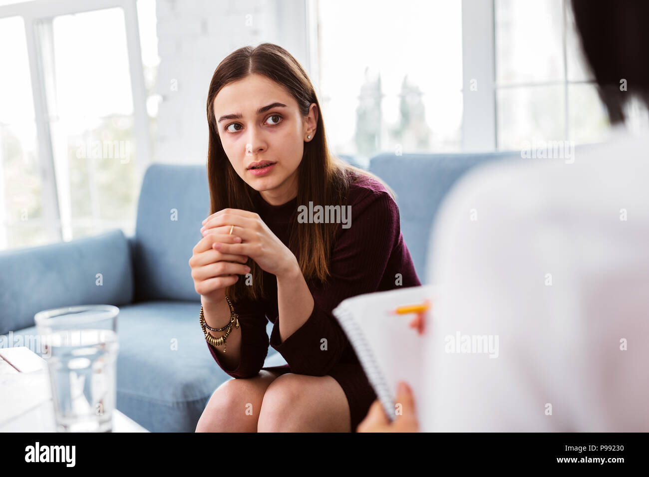 Expressive woman looking at the psychologist and changing her mind ...