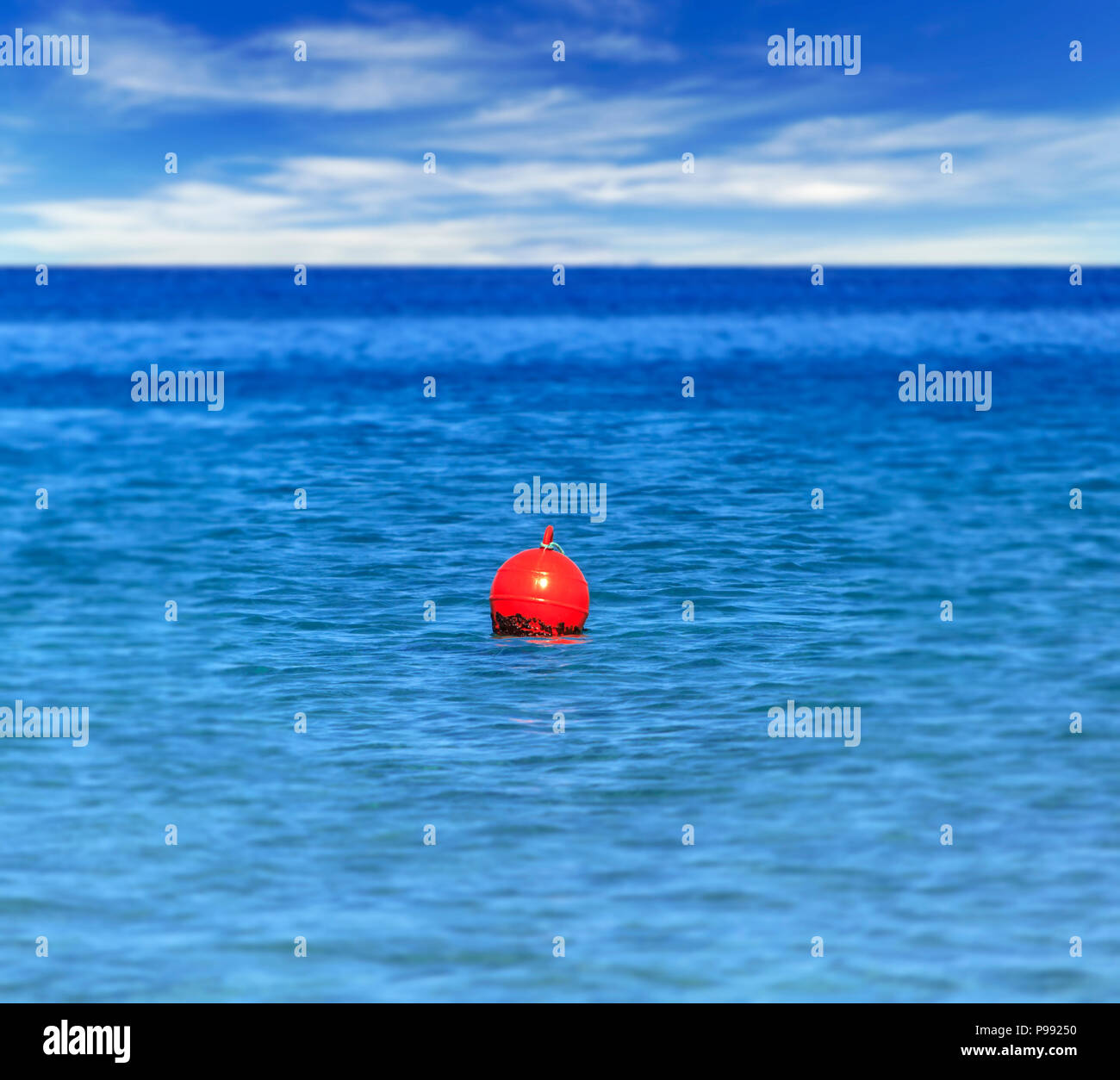 Buoy at blue ocean like mergency sign for sailing boat with cloudy sky ...