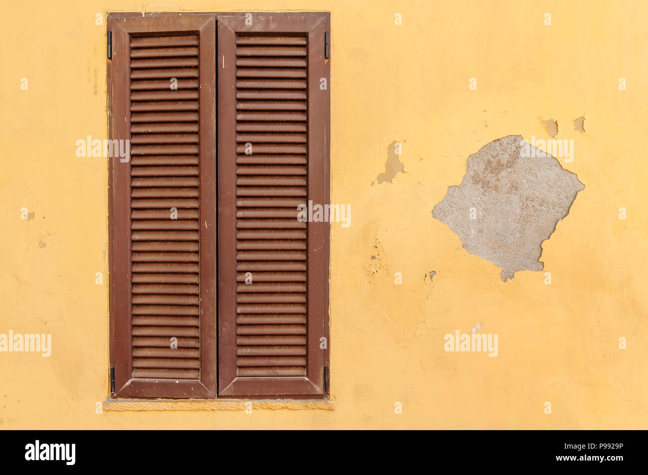 Brown wooden texture window frame on a yellow old cement house Stock ...