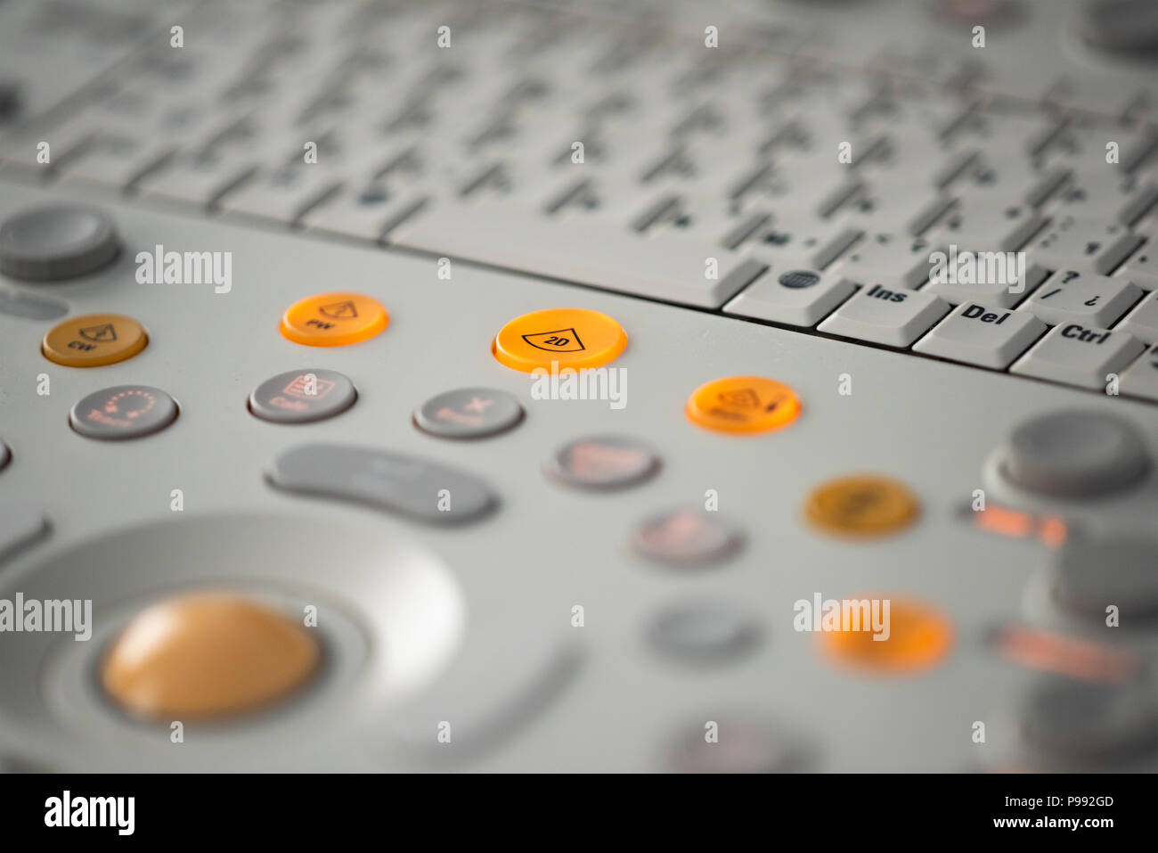 Keyboard with gray and orange buttons on the control panel of a modern ...
