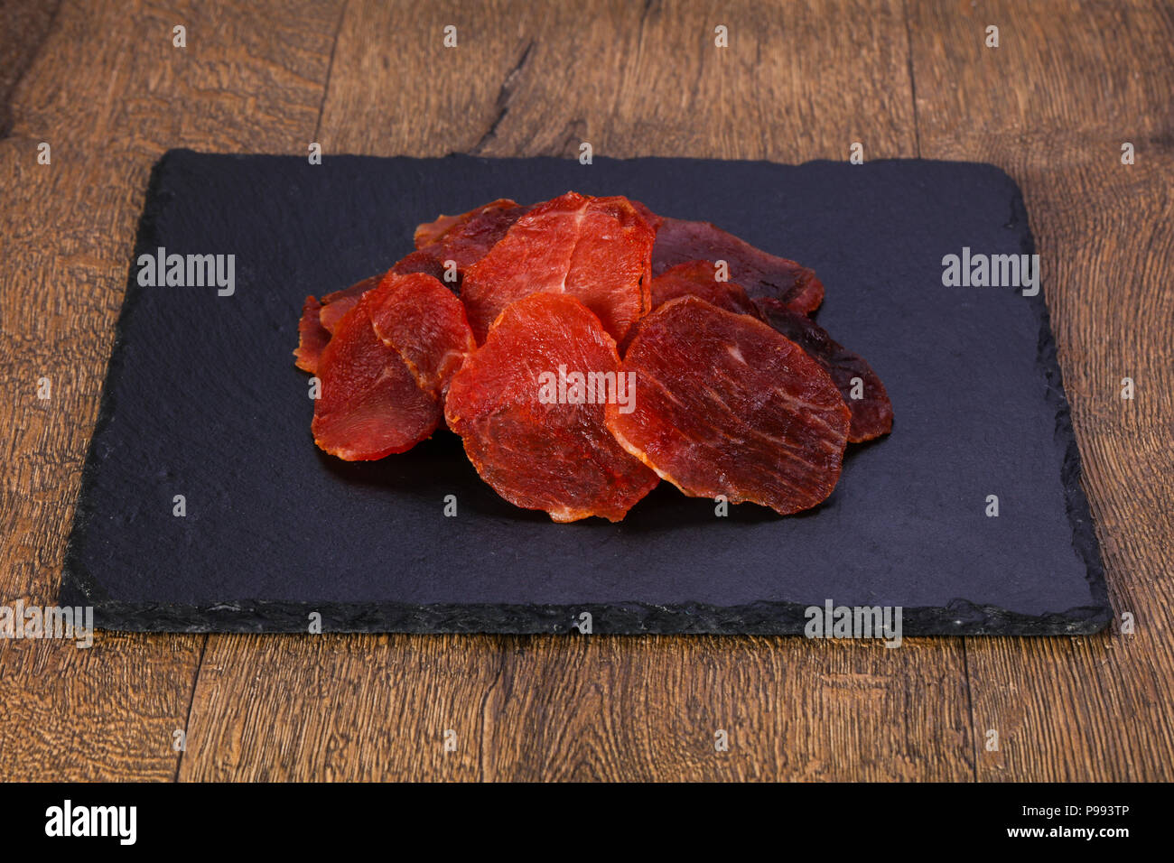 Dry pork meat heap over wooden Stock Photo - Alamy