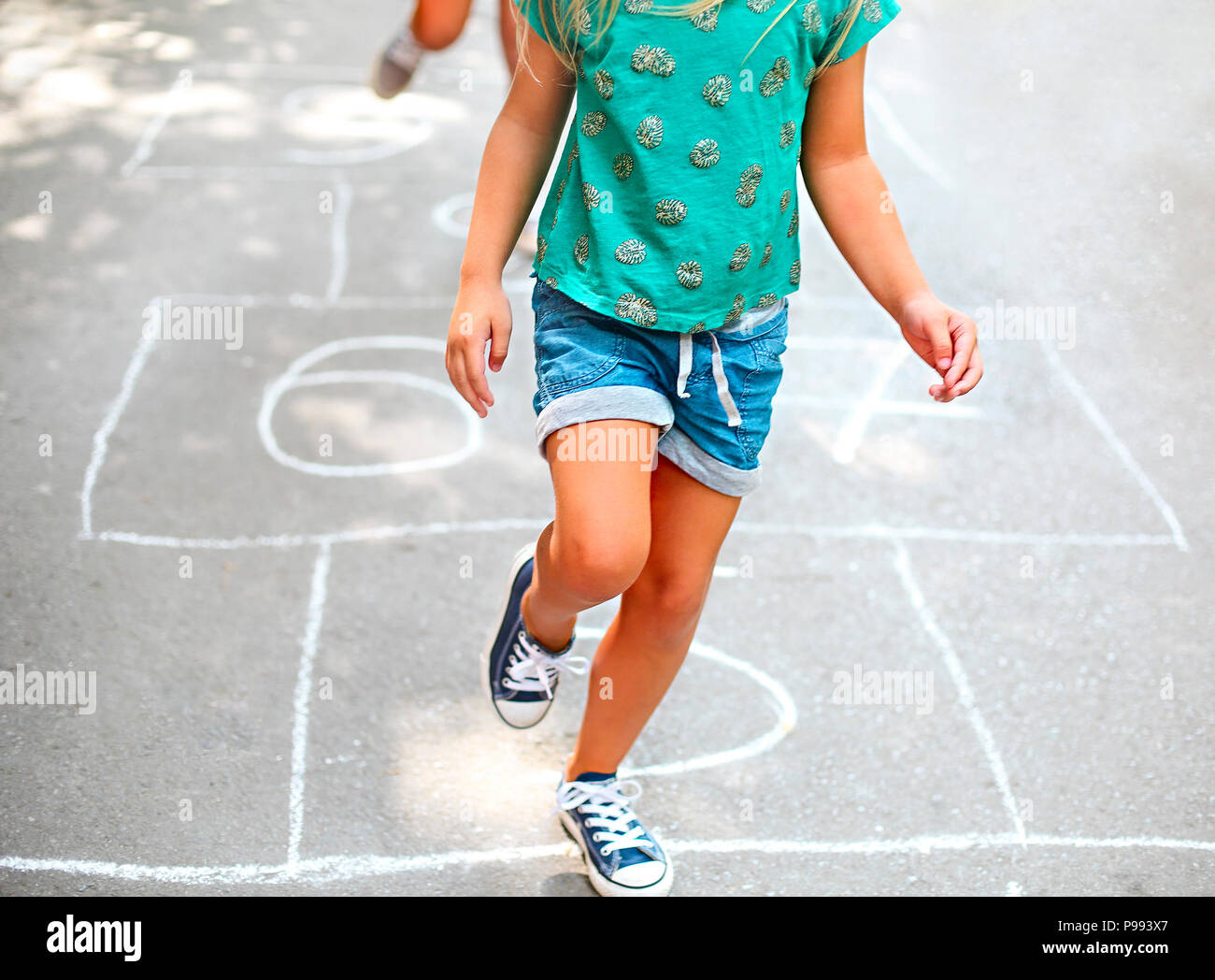 Kid playing hopscotch on playground outdoors, children outdoor ...